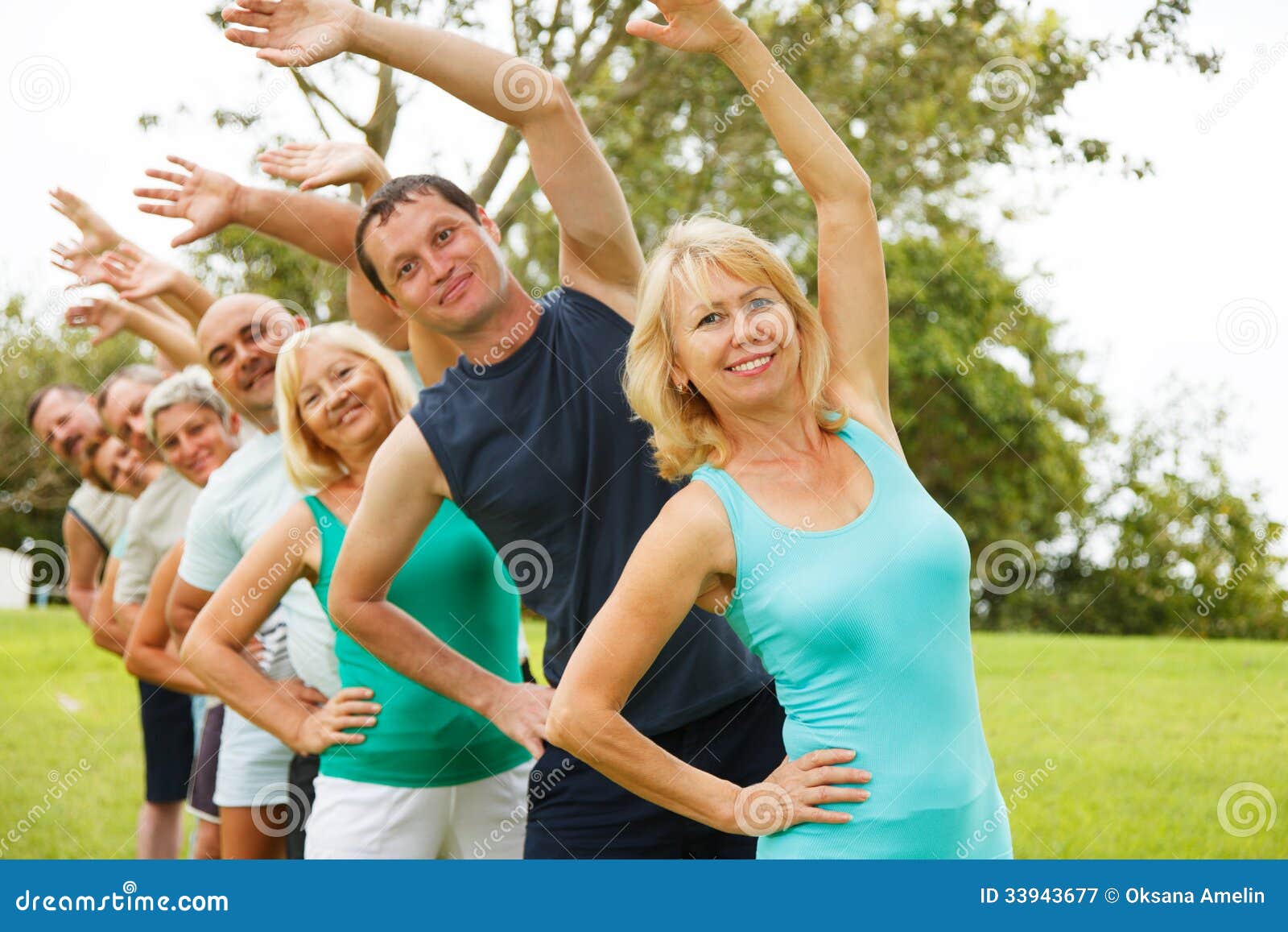 People Doing Flexibility Exercises.Focus on Foreground Stock Image ...