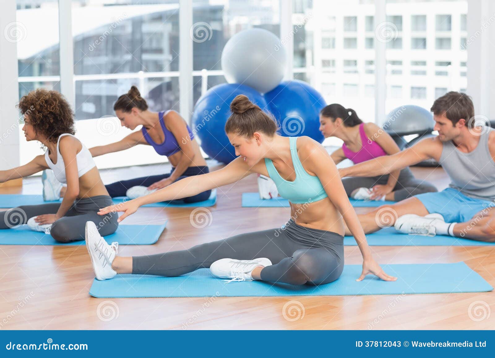 People Doing Stretching Exercises in Fitness Studio Stock Image - Image ...