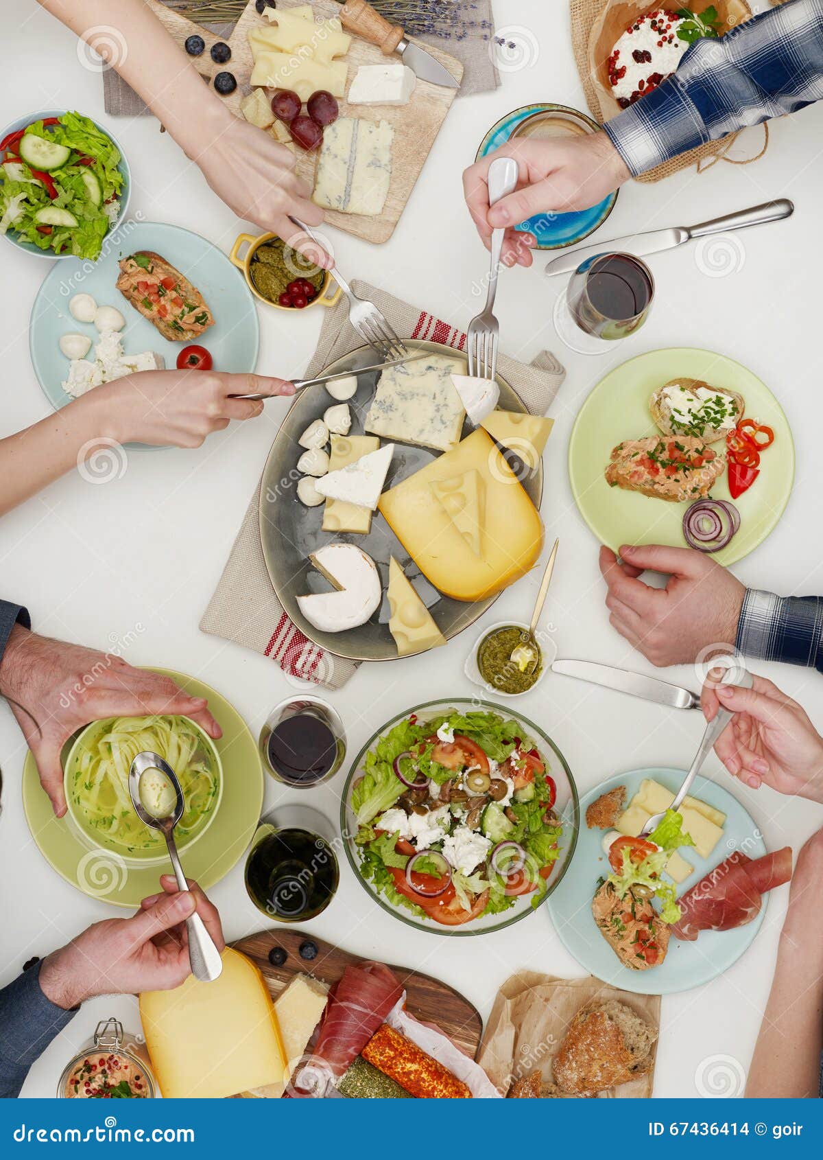 People eating dinner stock photo. Image of group, hand - 67436414