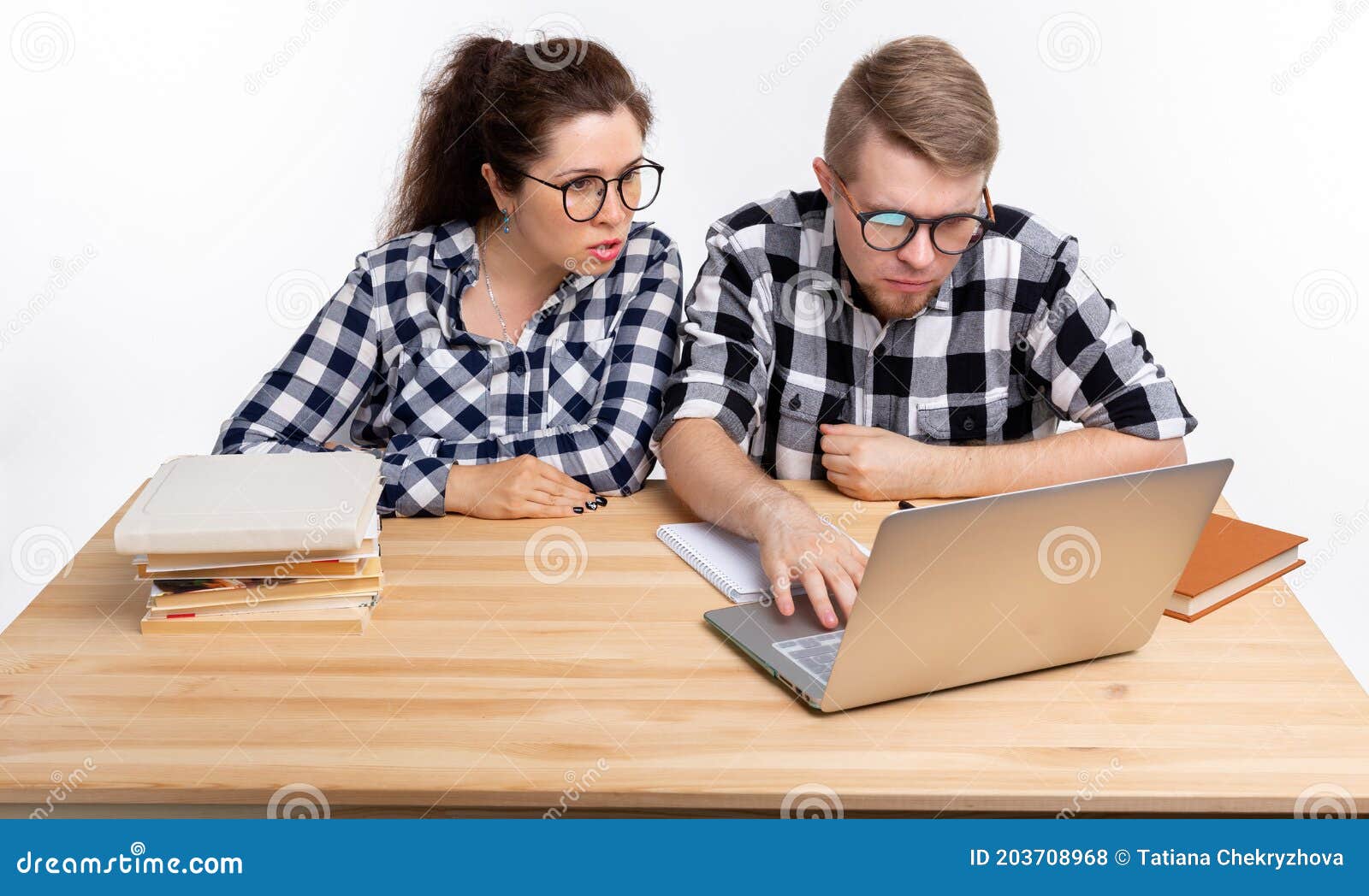 People and Education Concept - Two Puzzled Students in Plaid Shirts ...