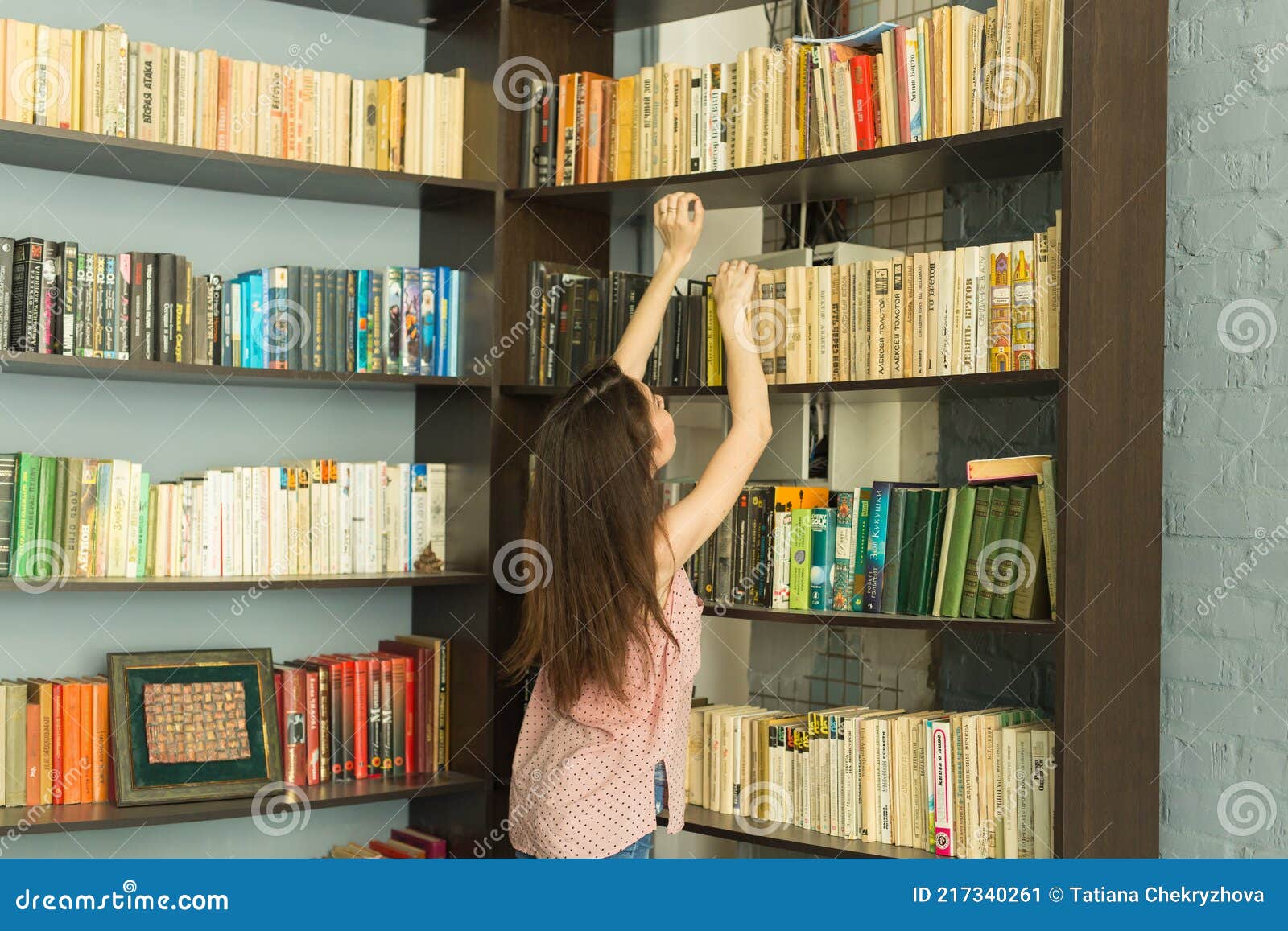 People, Education and Library Concept - Pretty Student Placing Book in ...