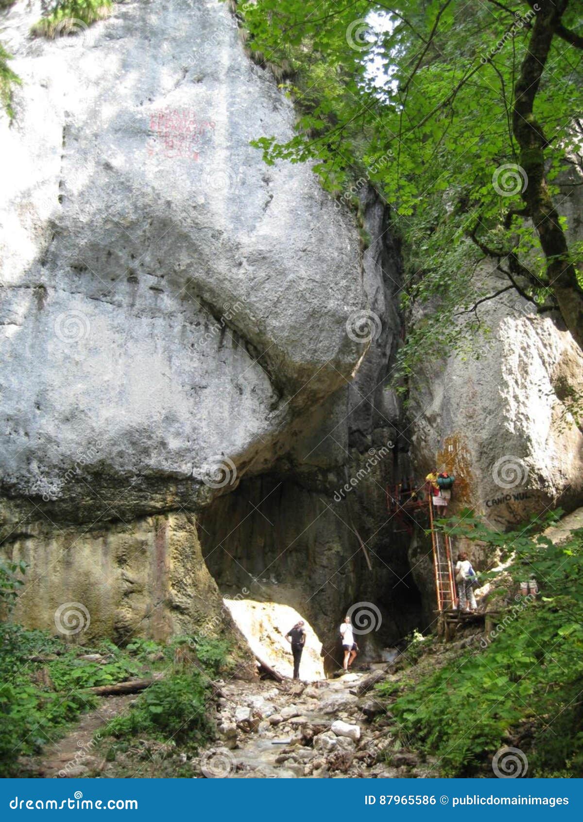 People Exploring Cave In Mountains Picture. Image: 87965586