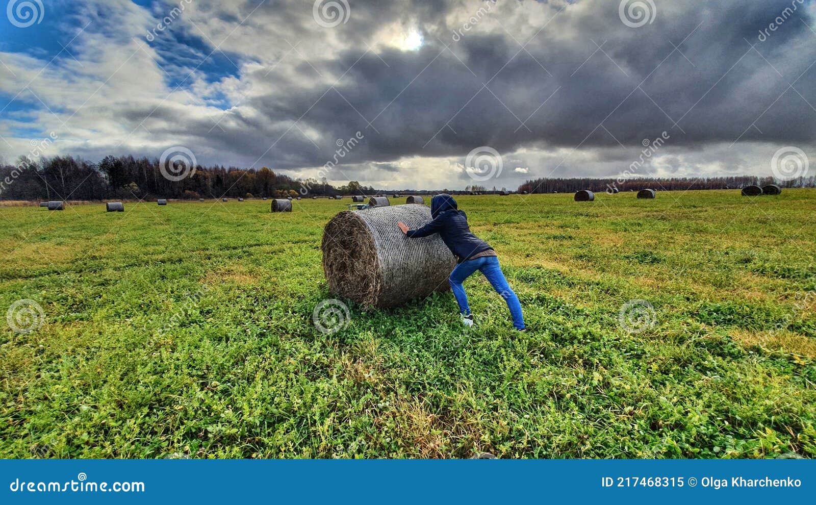 People in the Field with Haystacks Stock Image - Image of meadow, hill ...