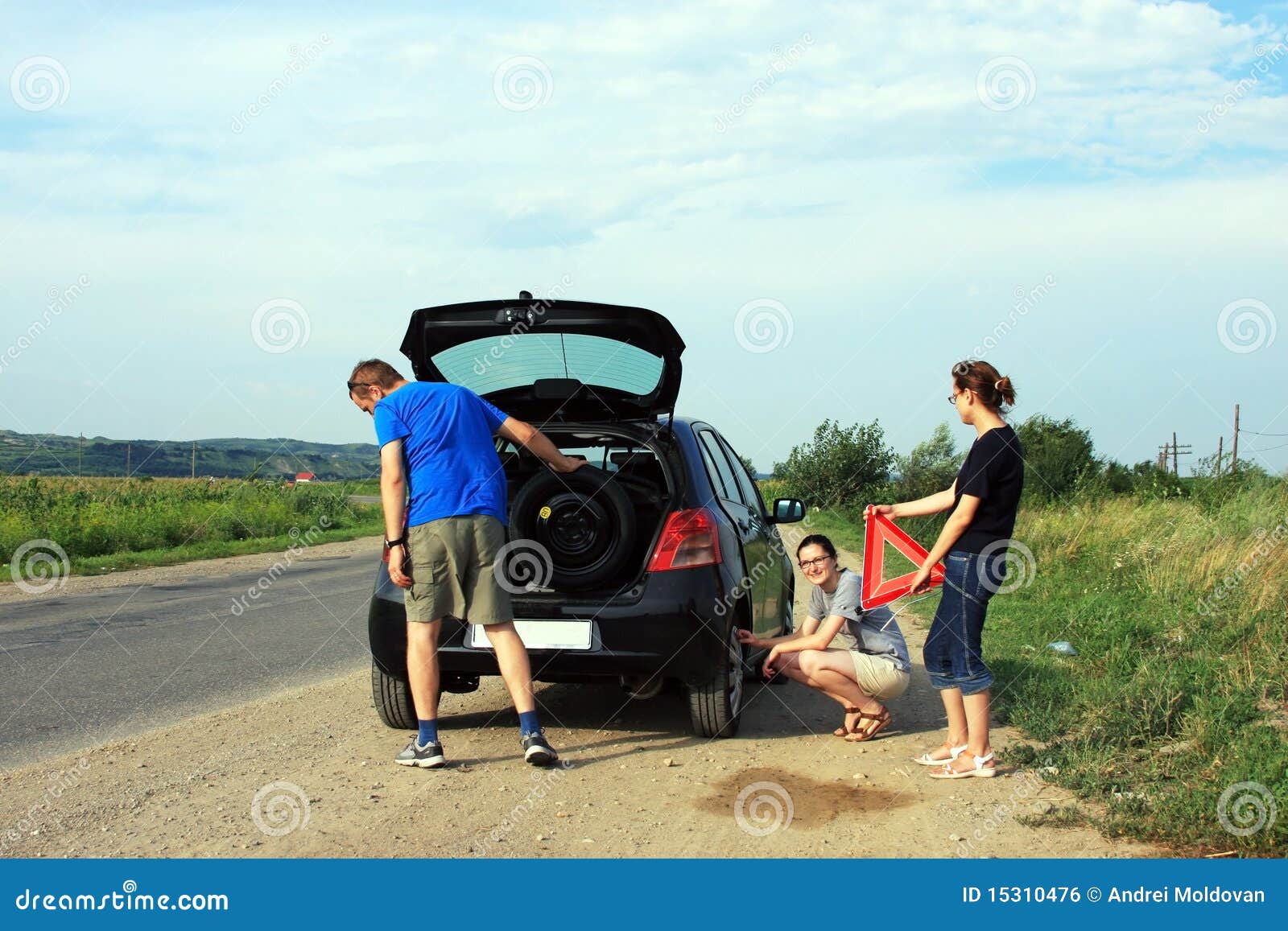 People fixing a flat tire stock photo. Image of head - 15310476
