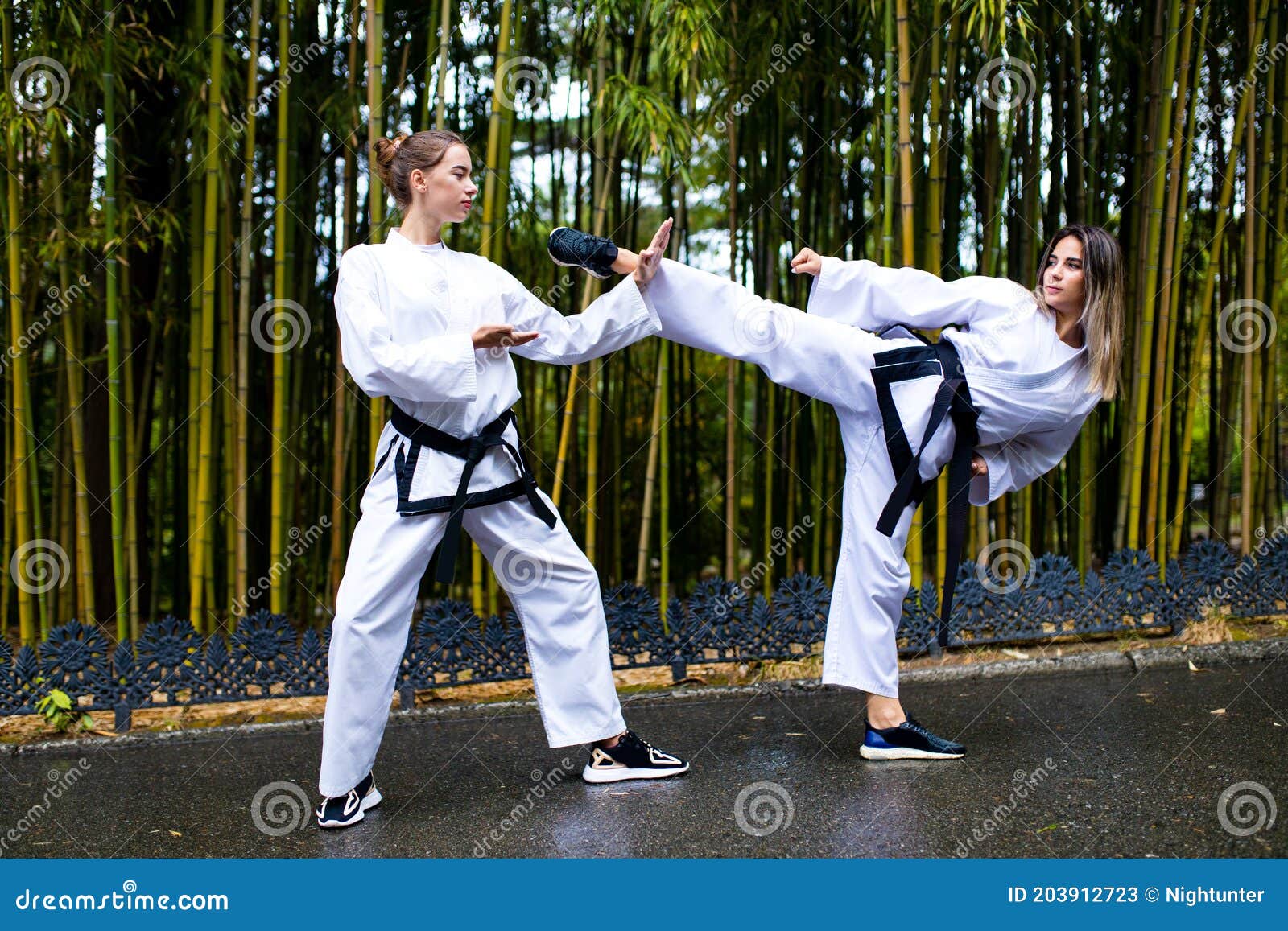 High Kicks Legs Two Athletes Are Training On The Red And Blue Mat ...