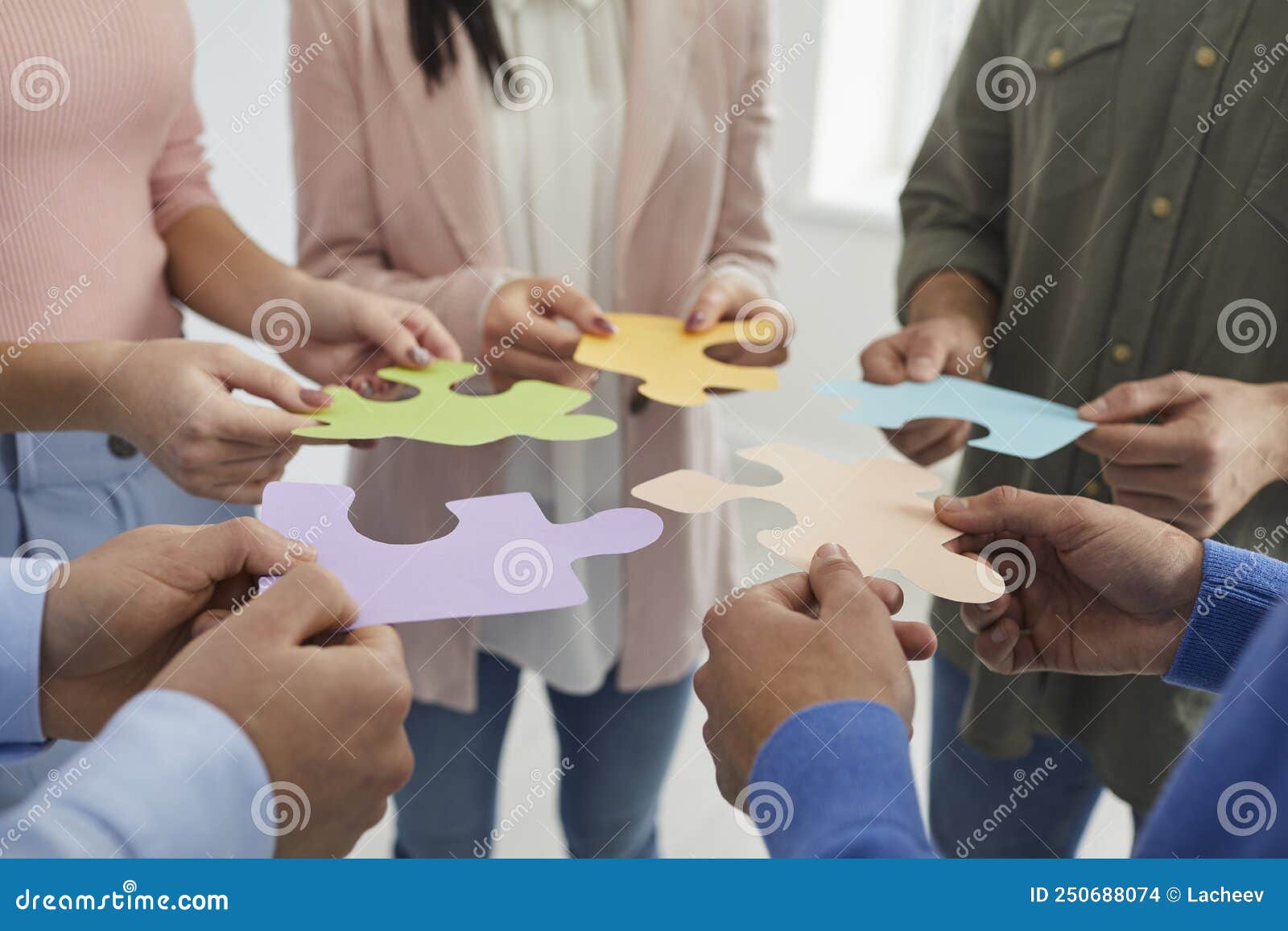 People Holding Colored Pieces of Puzzles Symbolizing Development and ...
