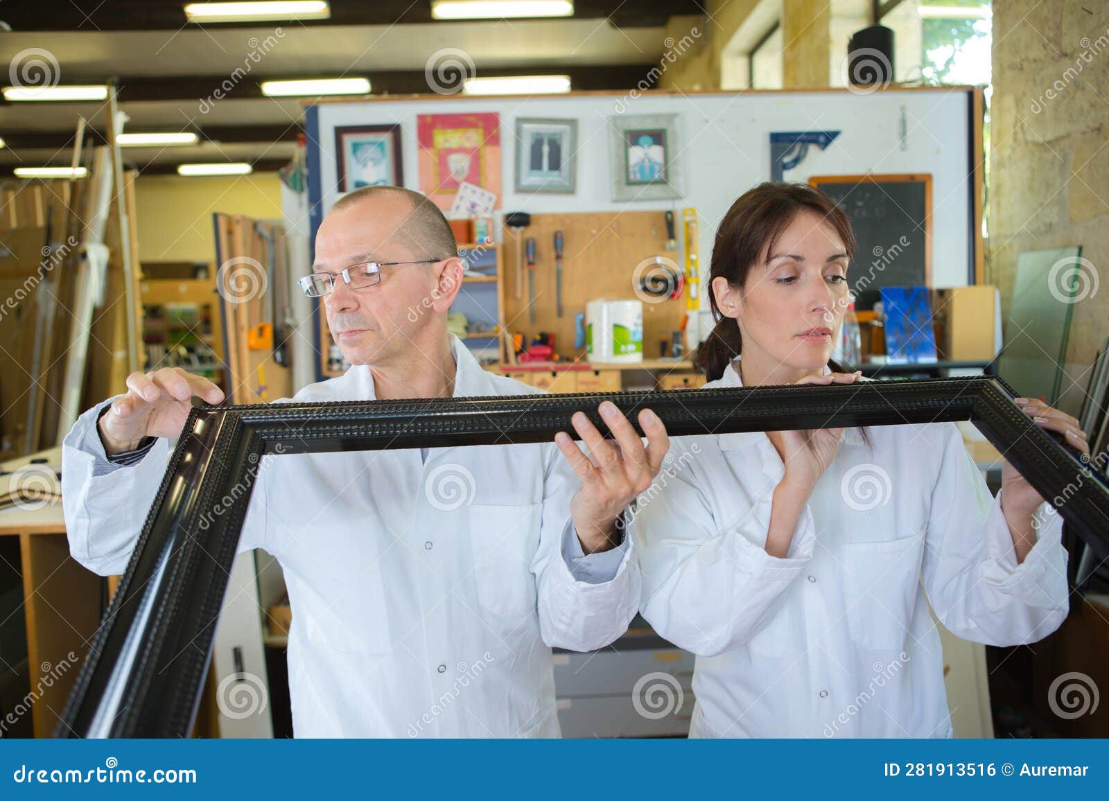People holding frame stock photo. Image of technician - 281913516