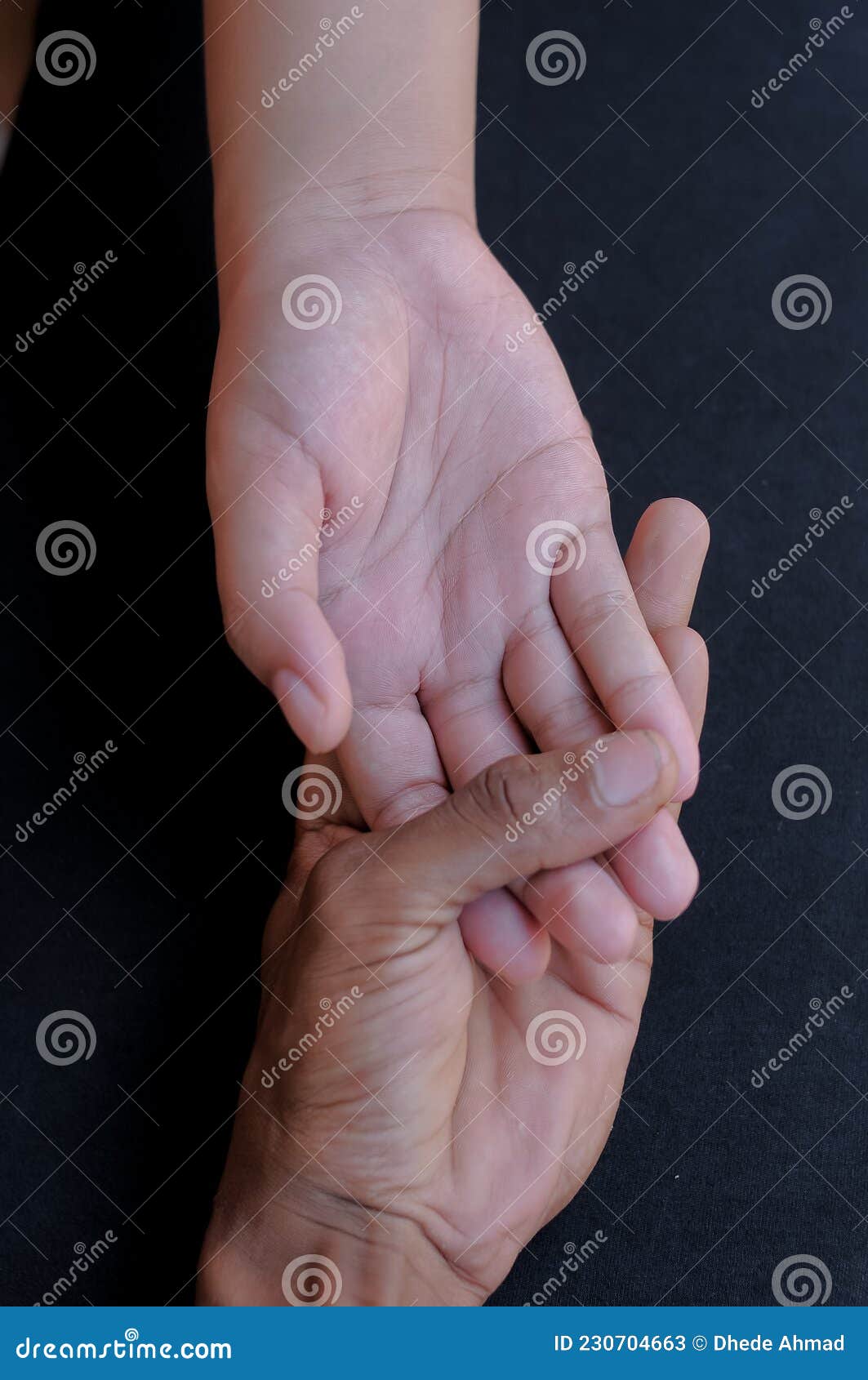 People Holding Hands on a Black Table Stock Image - Image of holding ...