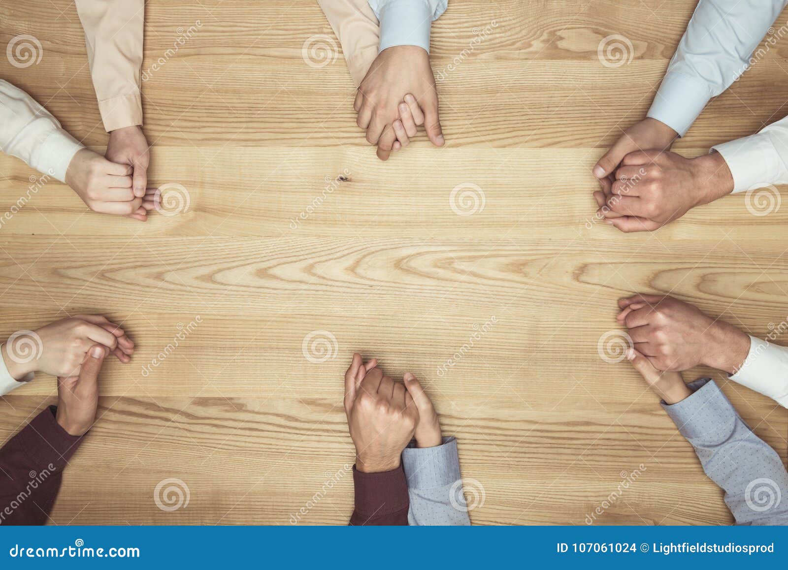 People Holding Hands on Wooden Tabletop Stock Photo - Image of partial ...