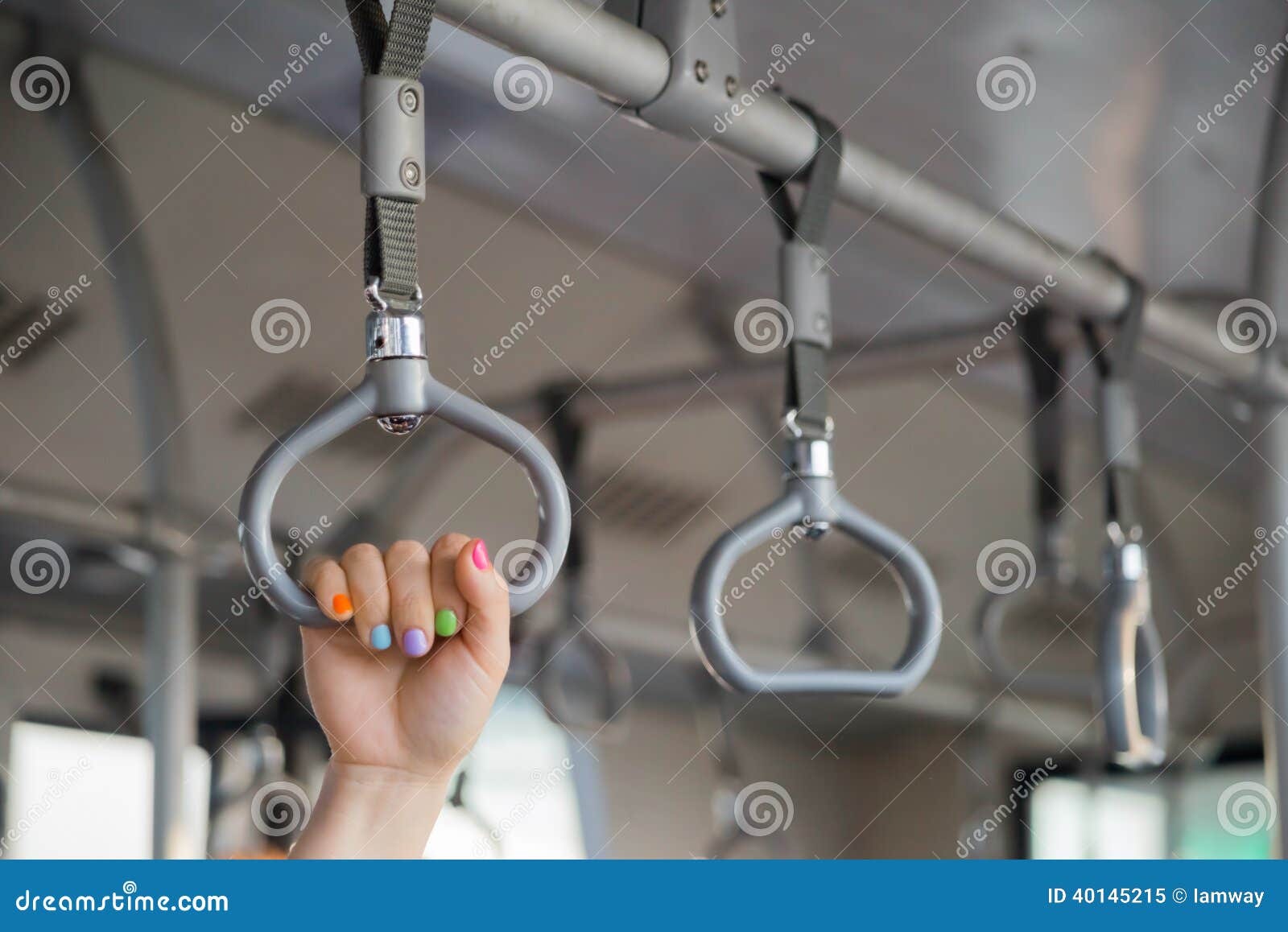 People Holding Onto a Handle on a Train Stock Image - Image of stand ...