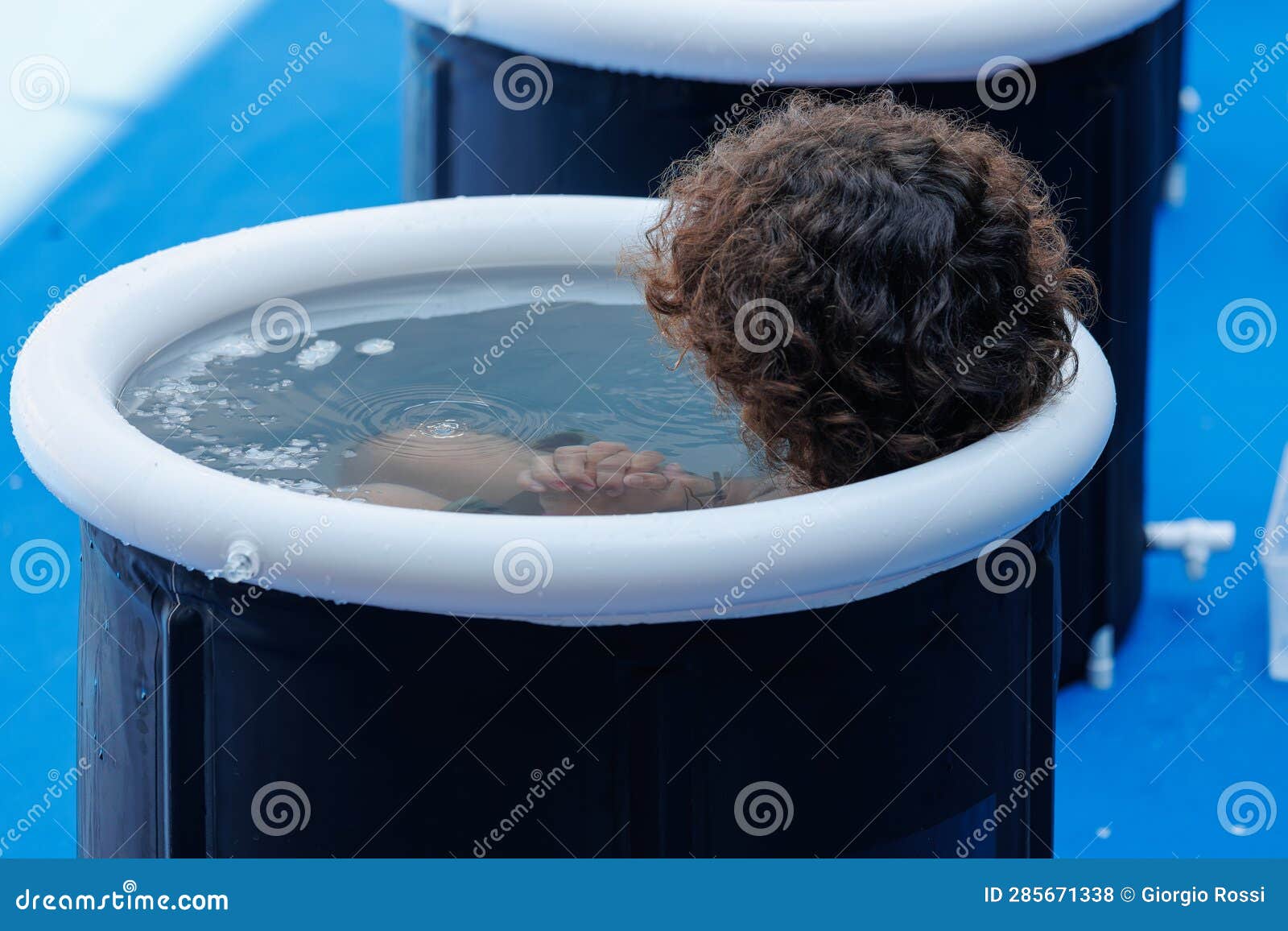 People Immersing Themselves in Circular Pools Filled with Water and Ice ...