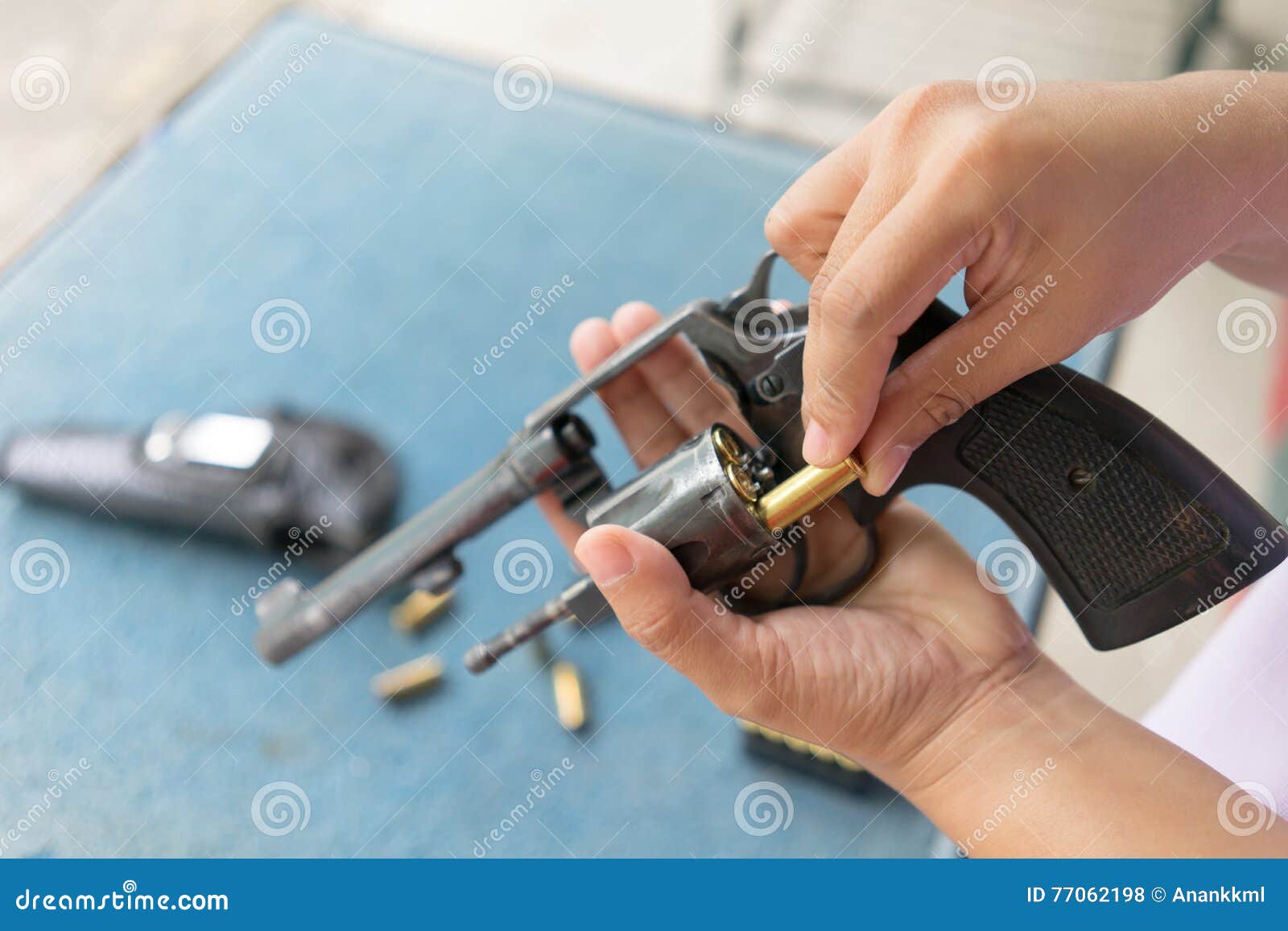 People Load Bullets into Revolver Gun Stock Photo - Image of danger ...