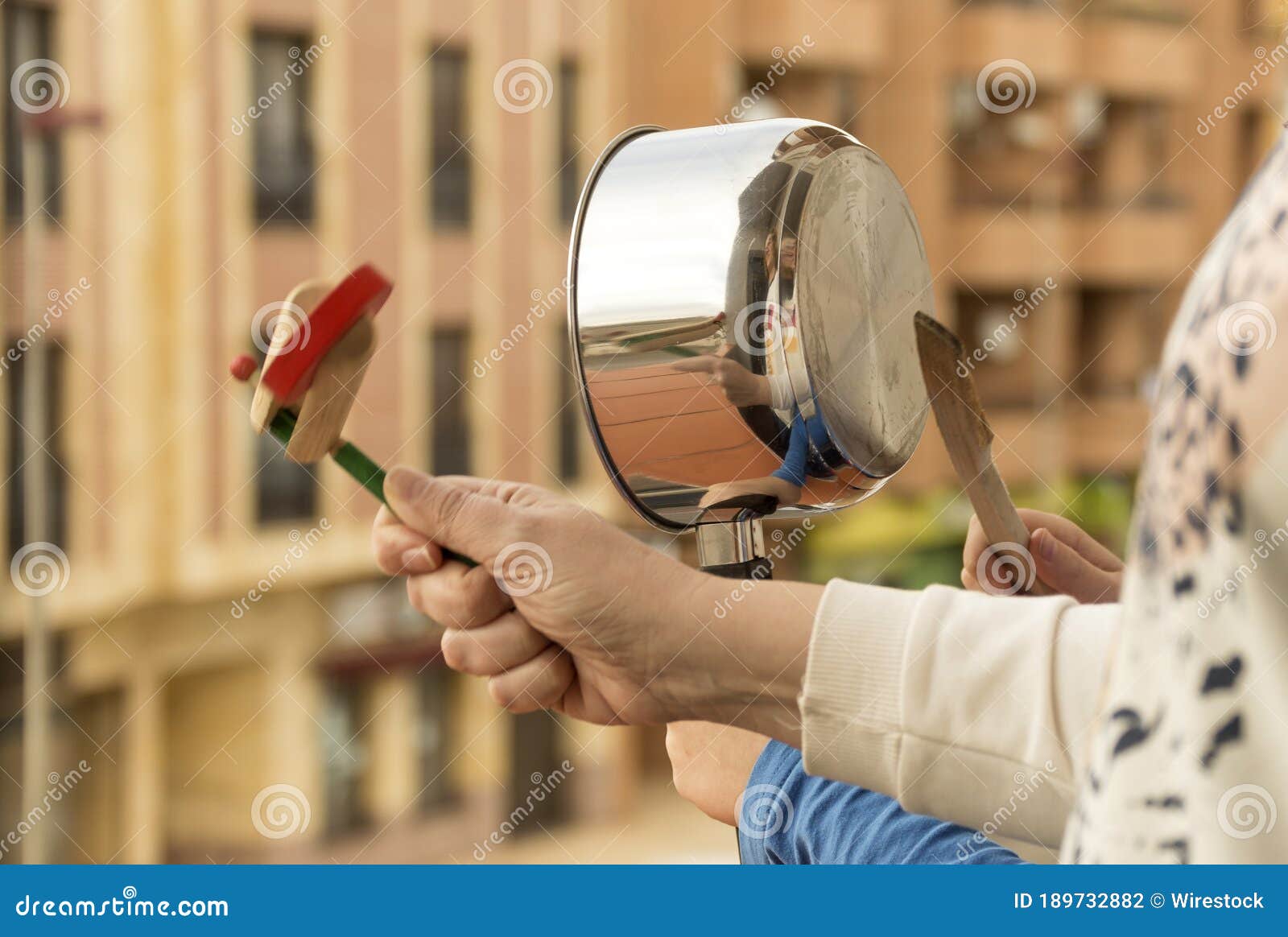 People Make Noise by Hitting the Pot with a Wooden Spoon Stock Photo ...