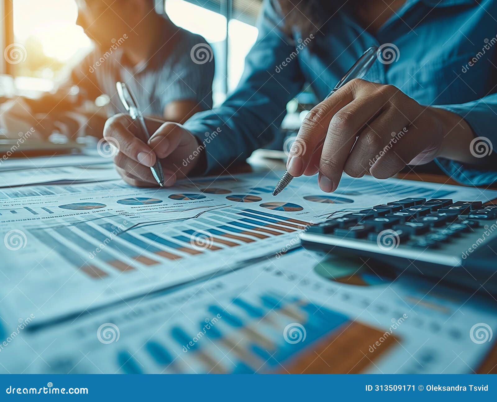 People Pointing Graph and Using Calculator during a Business Meeting ...