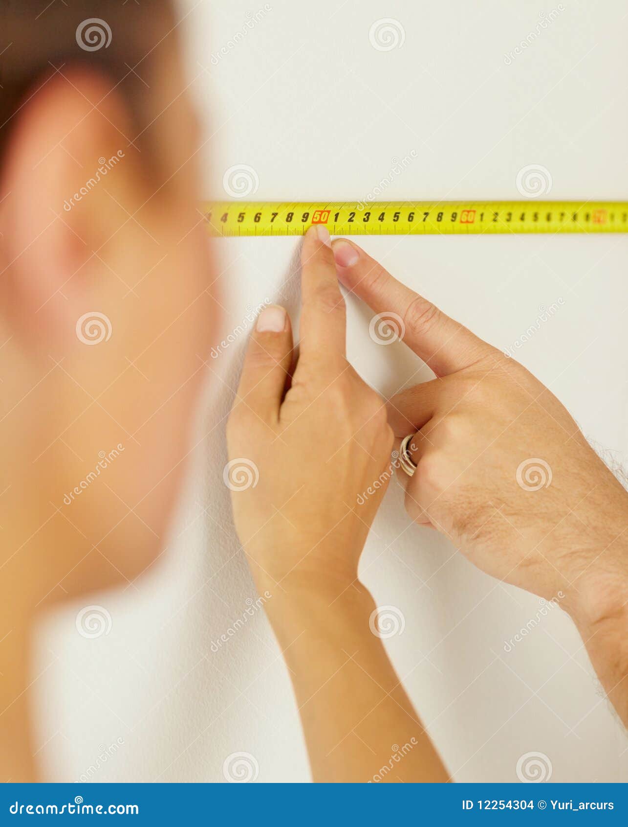 People Pointing at a Measuring Tape on the Wall Stock Photo - Image of ...