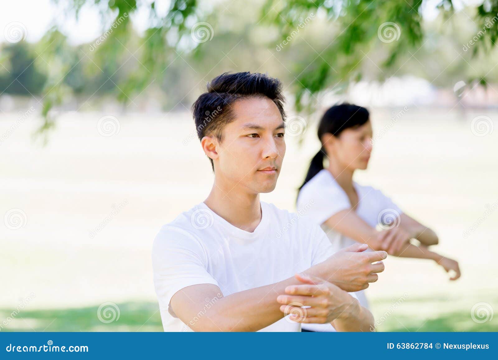 People Practicing Thai Chi in Park Stock Photo - Image of person ...
