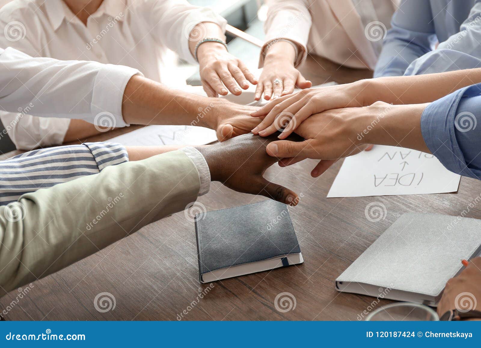 People Putting Hands Together at Table Stock Photo - Image of ...