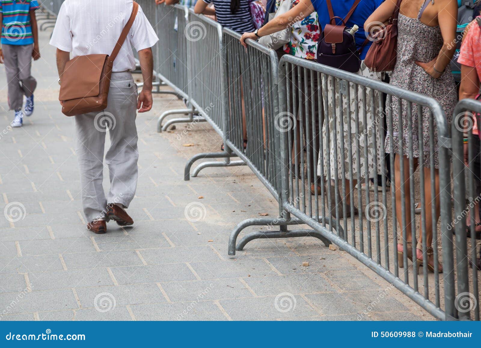 People Queue Behind a Barrier Stock Photo - Image of street, crowd ...