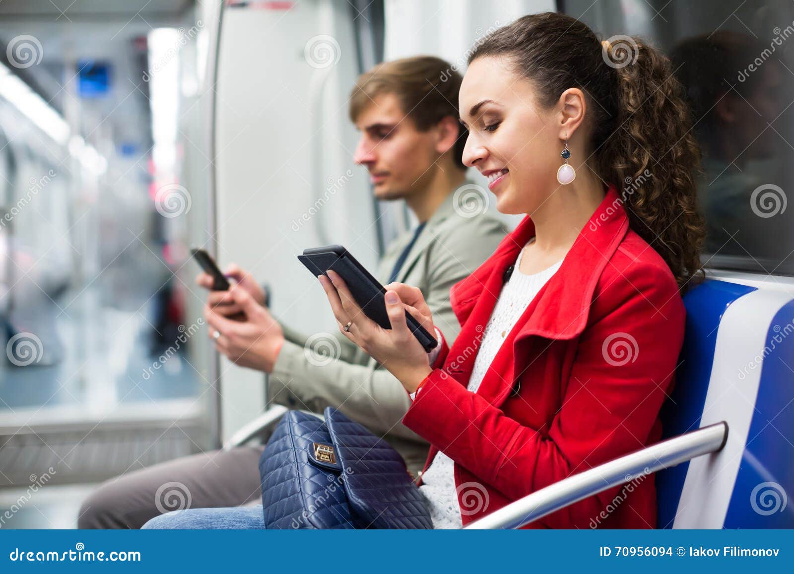 People Reading Smartphone and E-book in Metro Stock Photo - Image of ...