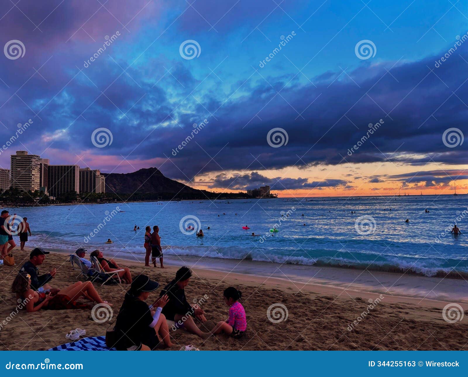 People Relaxing on the Beach at Sunset. Honolulu, Hawaii Editorial Stock Photo - Image of ...