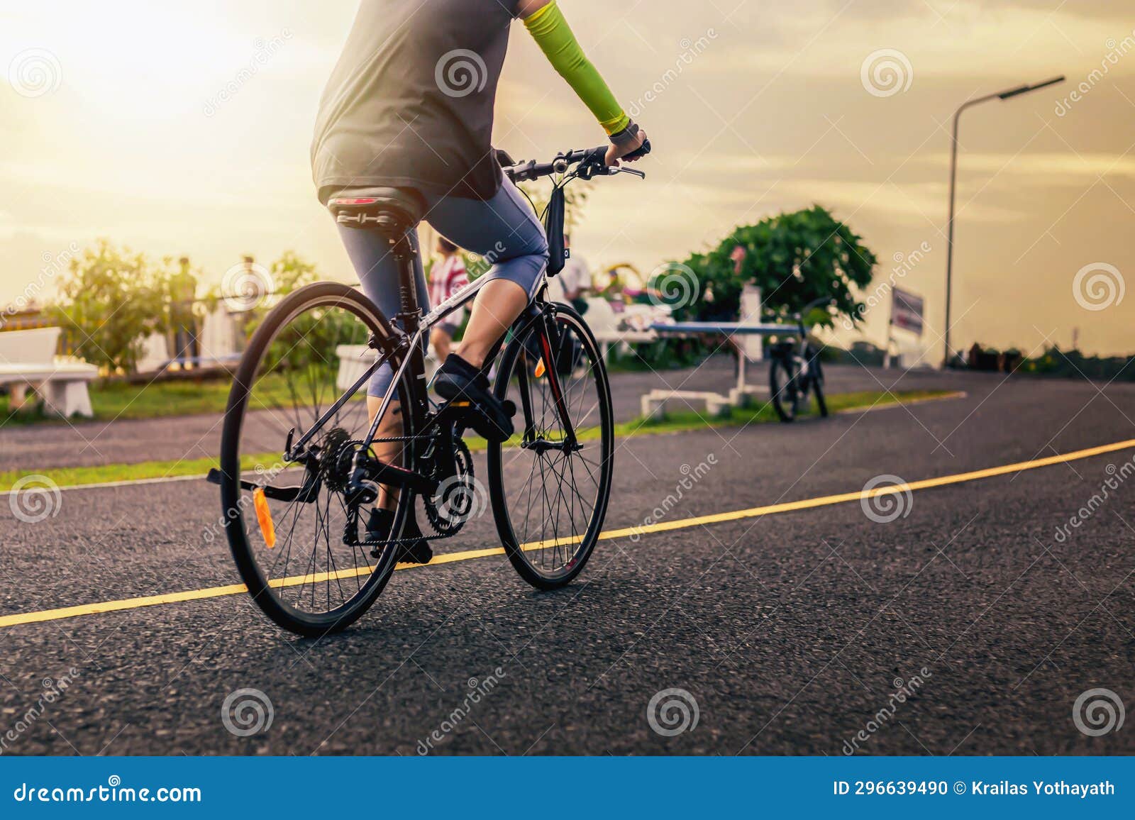 People Riding Exercise Bikes at the Park in the Evening Stock Photo ...