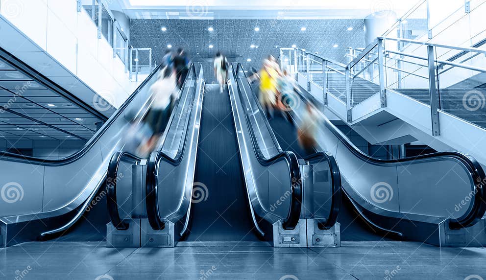 People Rushing in Escalator Lobby Stock Photo - Image of group, blurred ...
