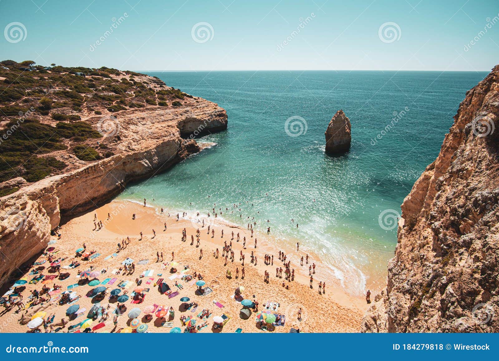 People on the Sandy Beach Near the Cliffs and the Calm Sea Stock Photo ...