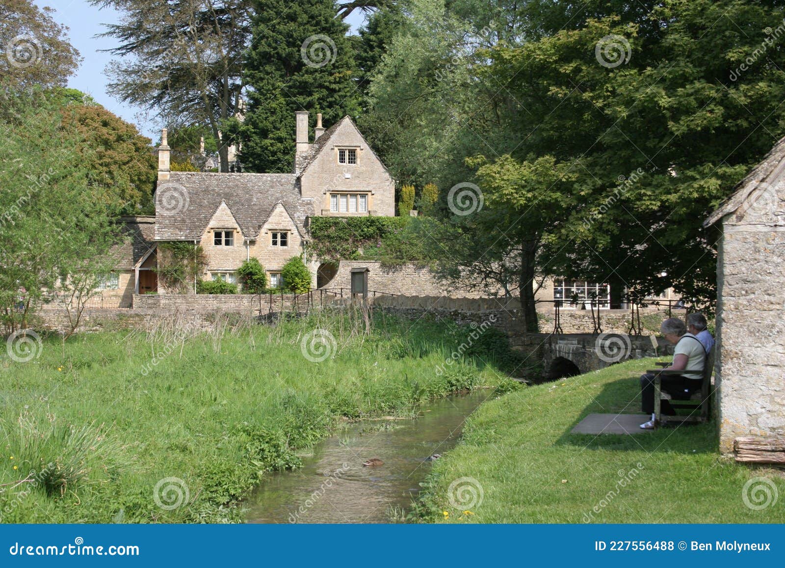 People Sat by the River Coln in Bibury, Gloucstershire in the UK ...