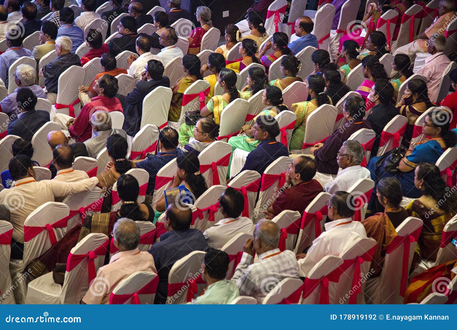 People are Sitting on Chairs and Watching a Function in a Hall ...