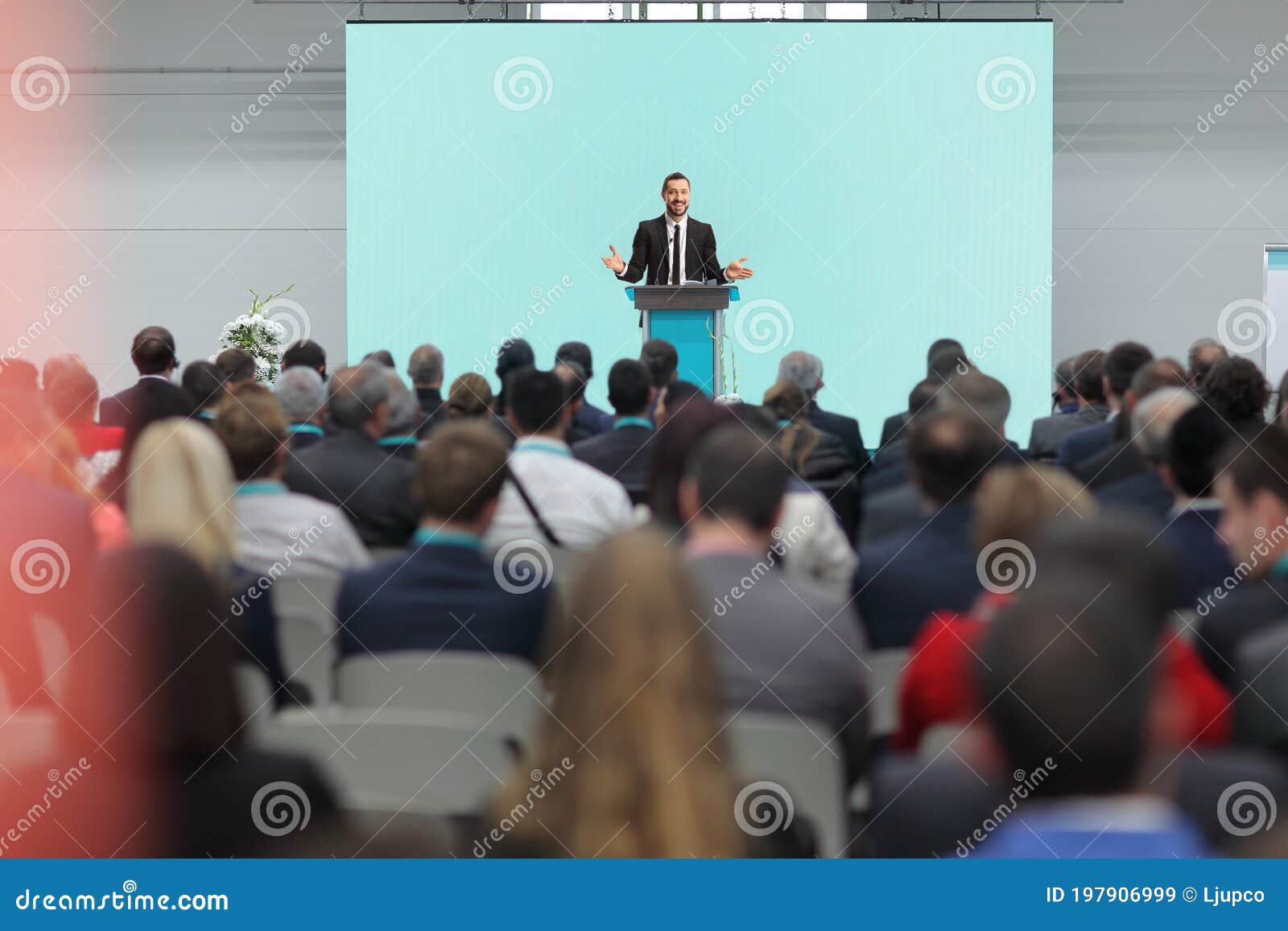 People Sitting in a Conference Hall and a Man in a Suit Giving a Speech ...