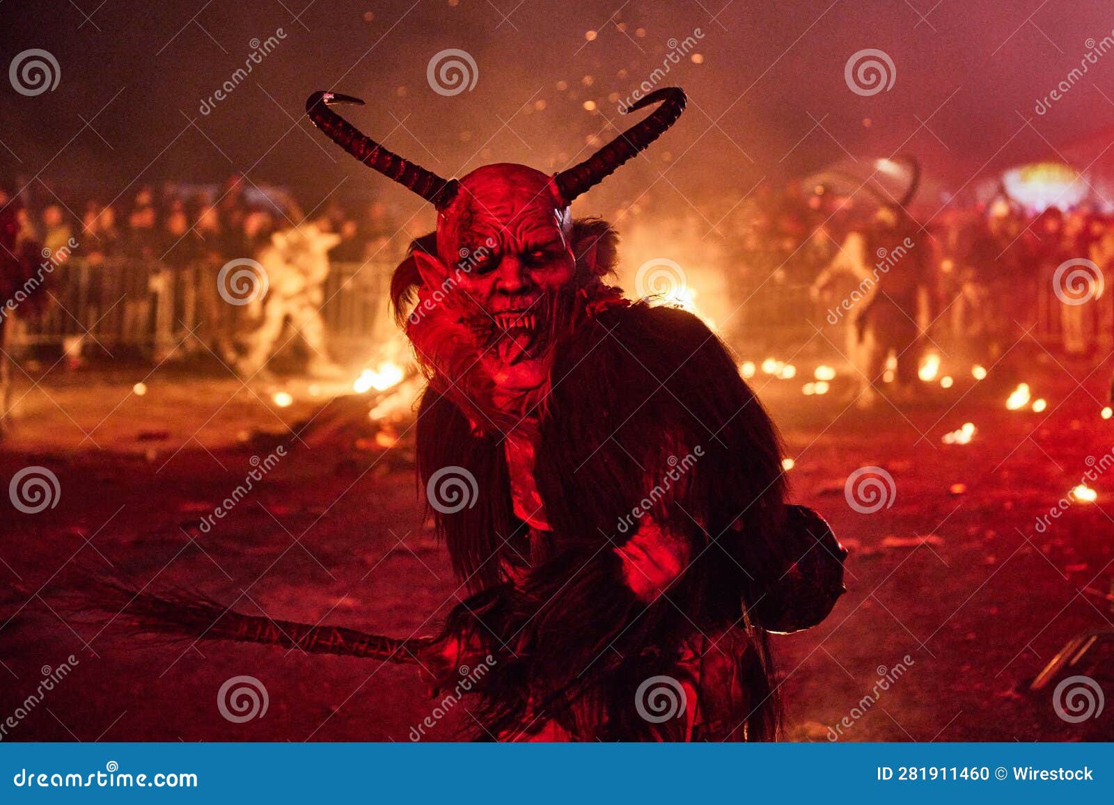 People Standing in Front of a Fire and Some are Dressed in Demon ...