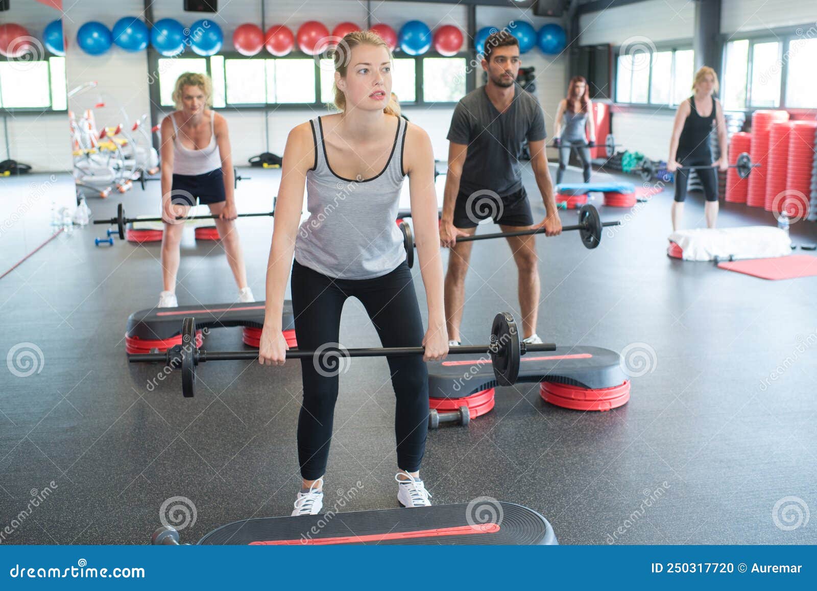 People in Step Exercise Class Holding Weights Stock Photo - Image of ...