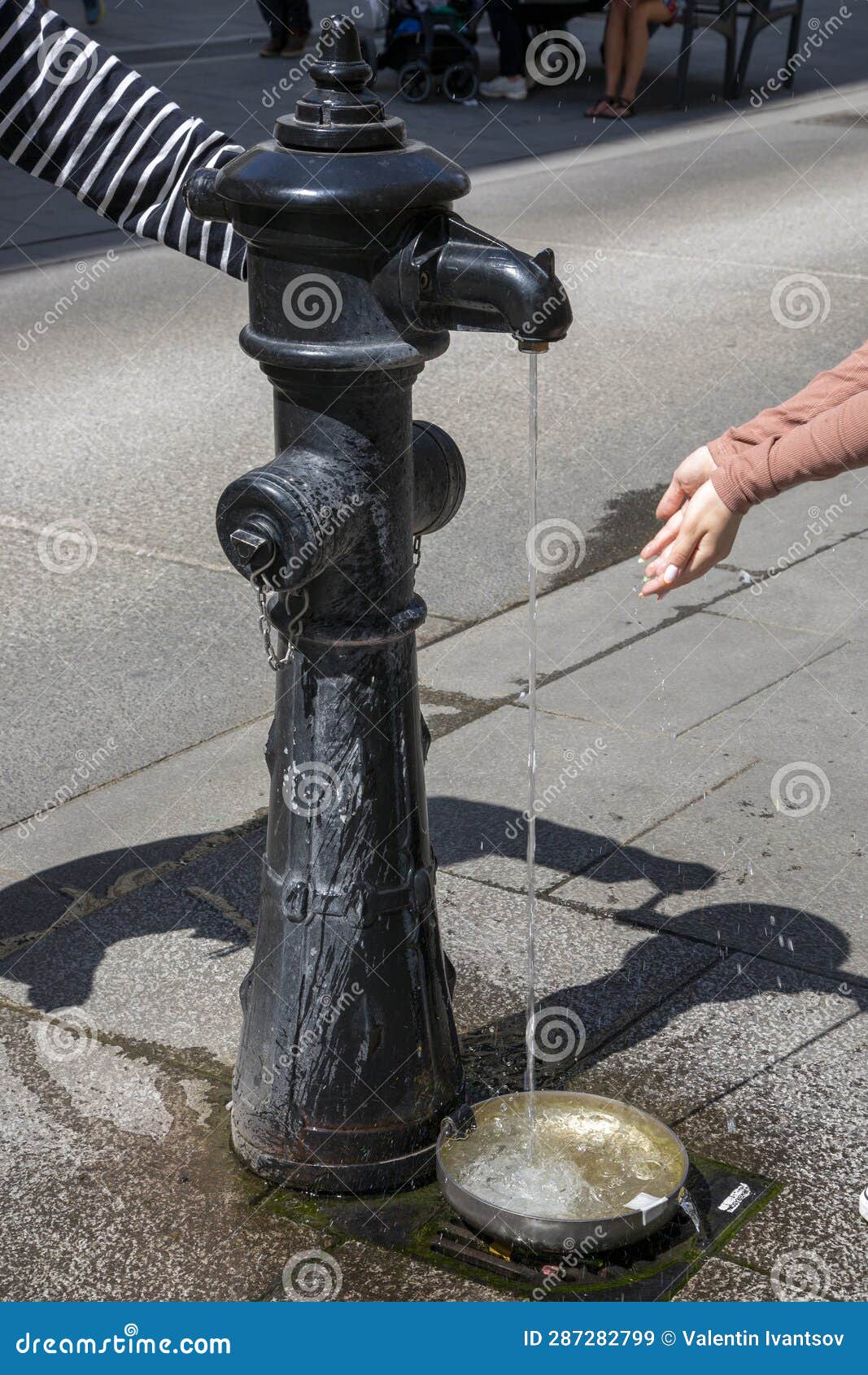 People on the Street of Vienna Drink Water from a Water Column Stock ...