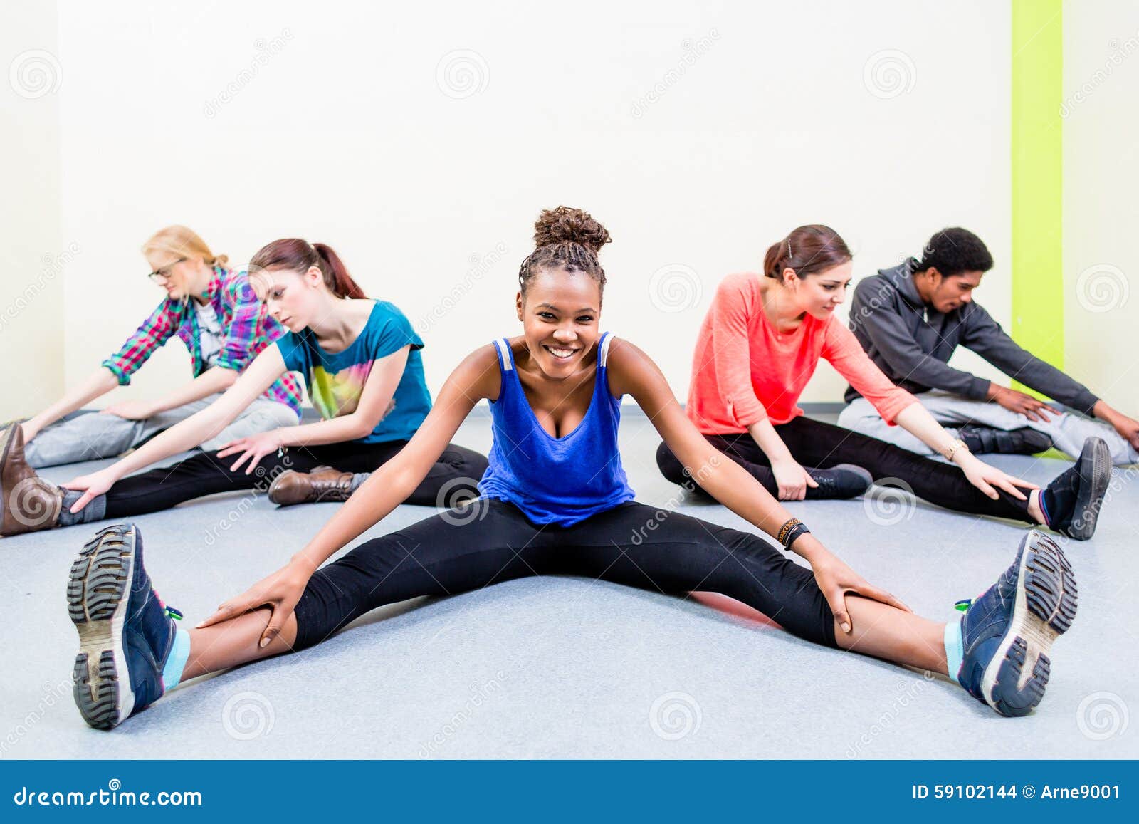 People Stretching Legs in Gymnastics Gym Stock Photo - Image of group ...