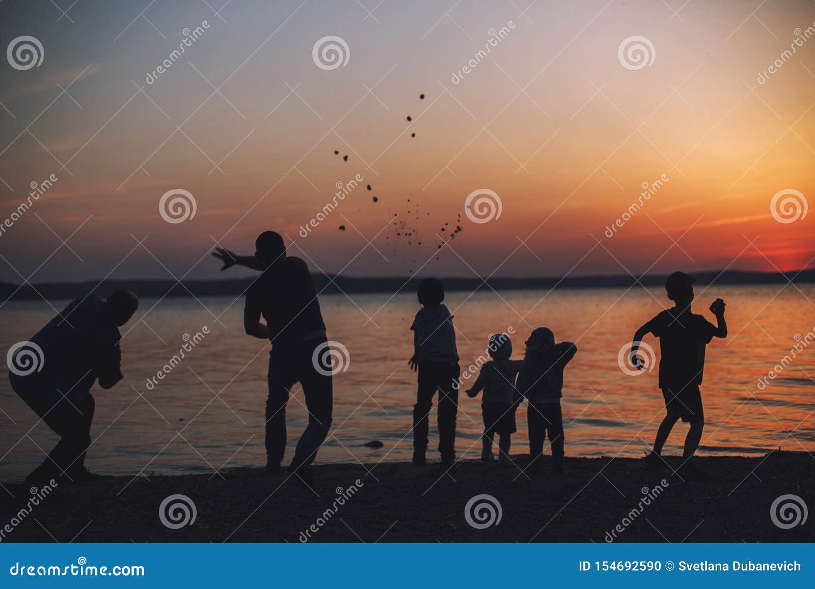People Throwing Stones into the Water Stock Photo - Image of father ...