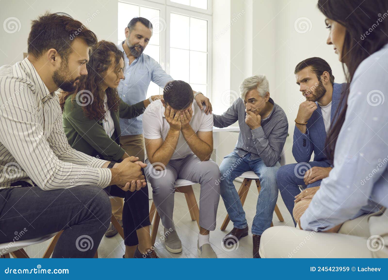 People Supporting and Comforting a Crying Young Man during a Group ...