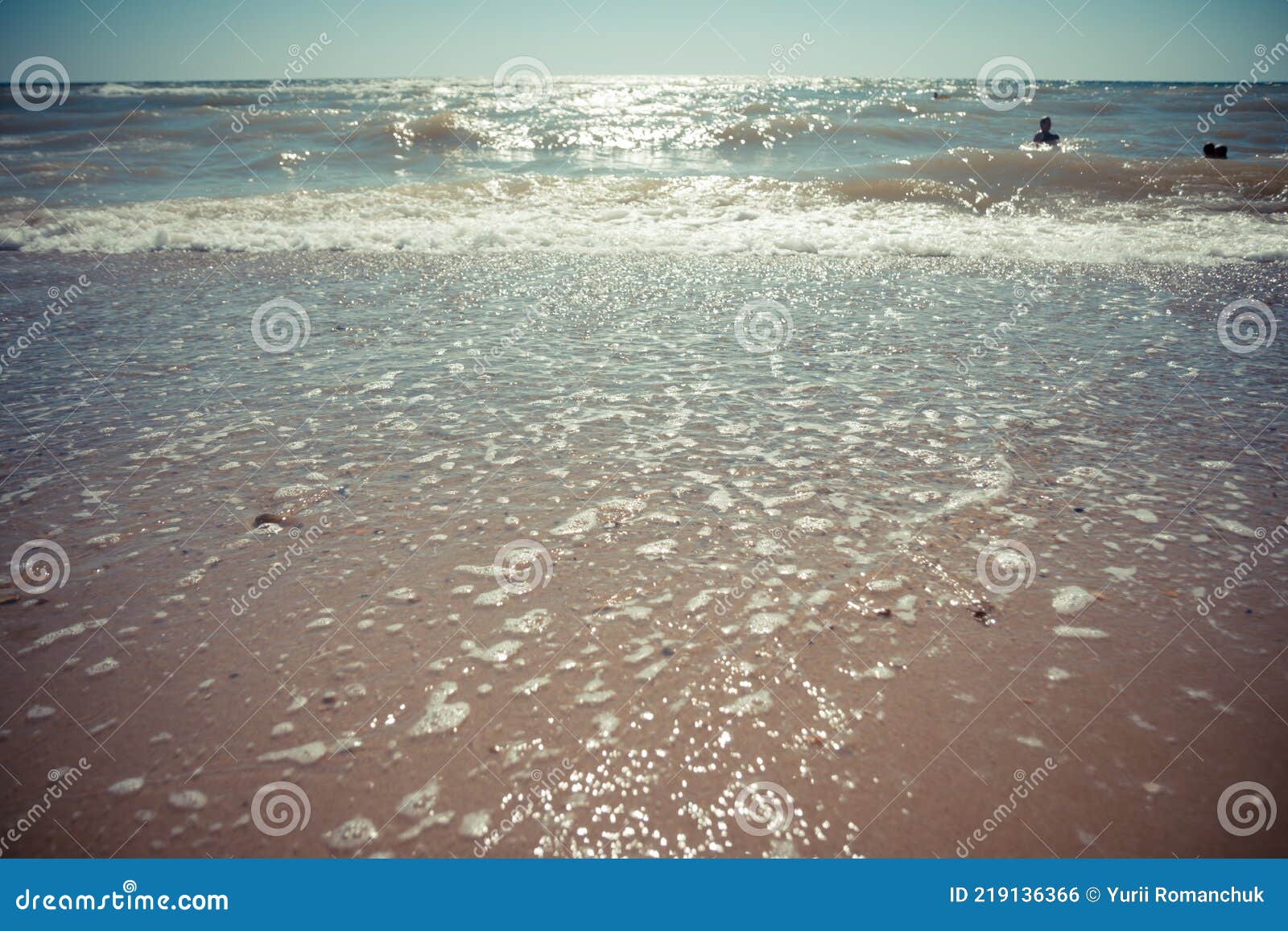 People Swimming in the Rough Sea. View from the Sandy Beach Stock Photo ...