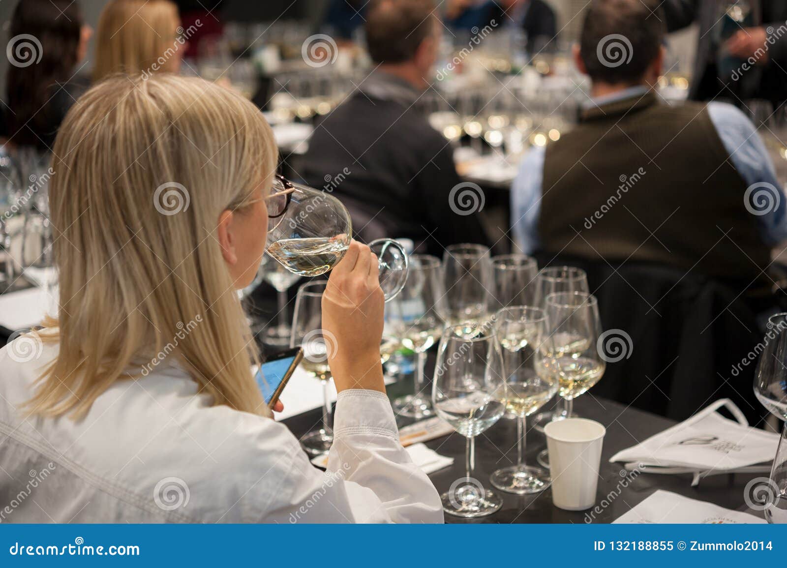 People Tasting White Wine and Making Notes at Degustation Card ...