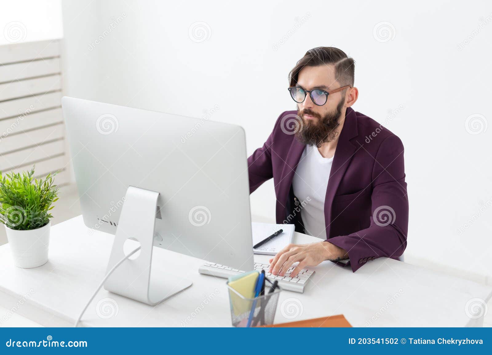 People and Technology Concept - Handsome Man with Beard Working on at ...