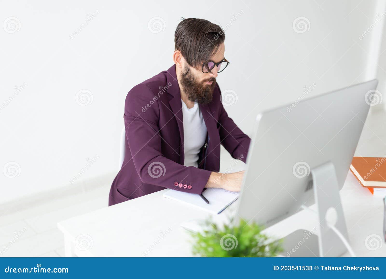 People and Technology Concept - Man Sits and Works at the Computer ...