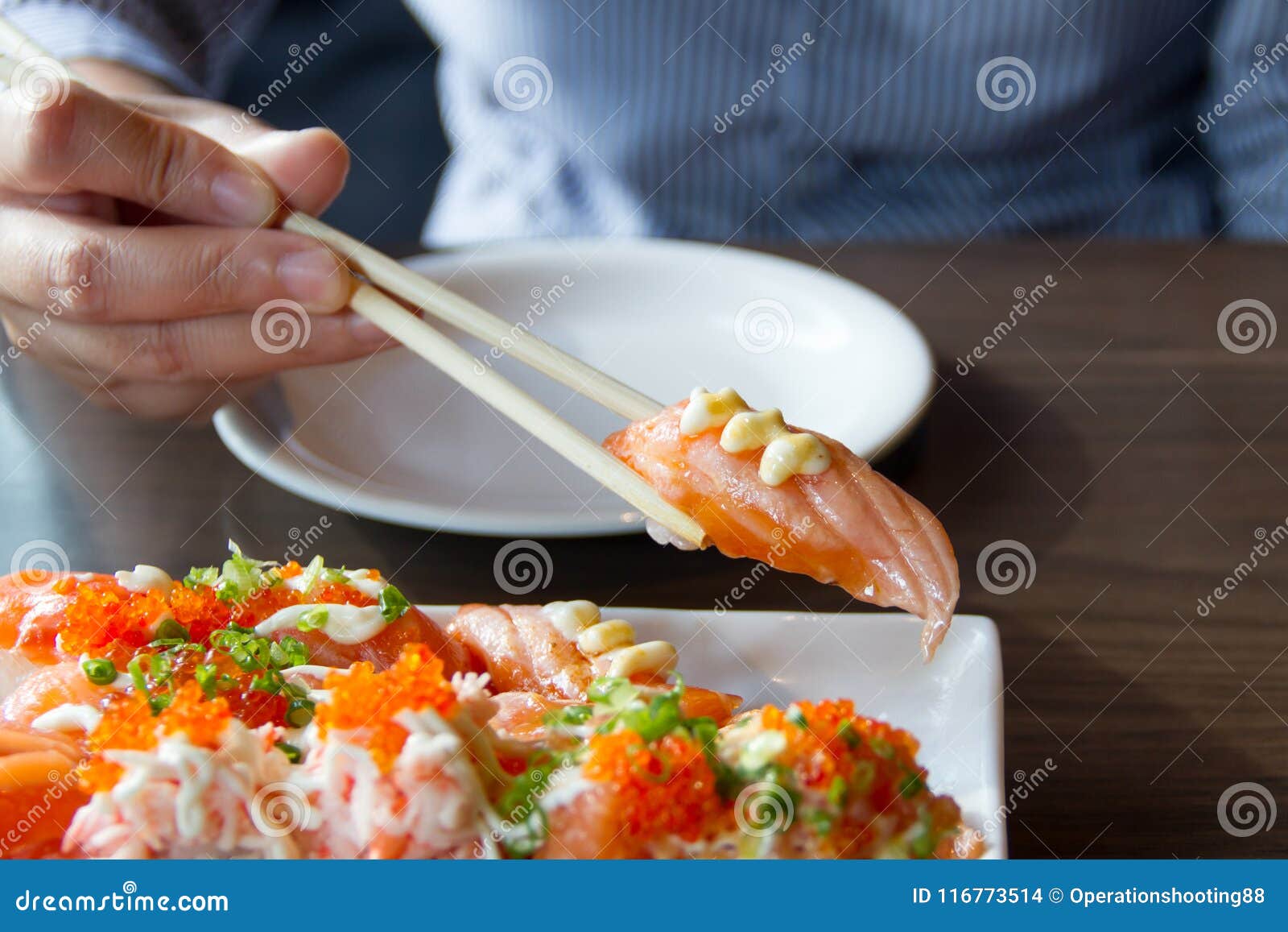 People Use Chopsticks To Pick Up Sushi. Stock Photo - Image of ...