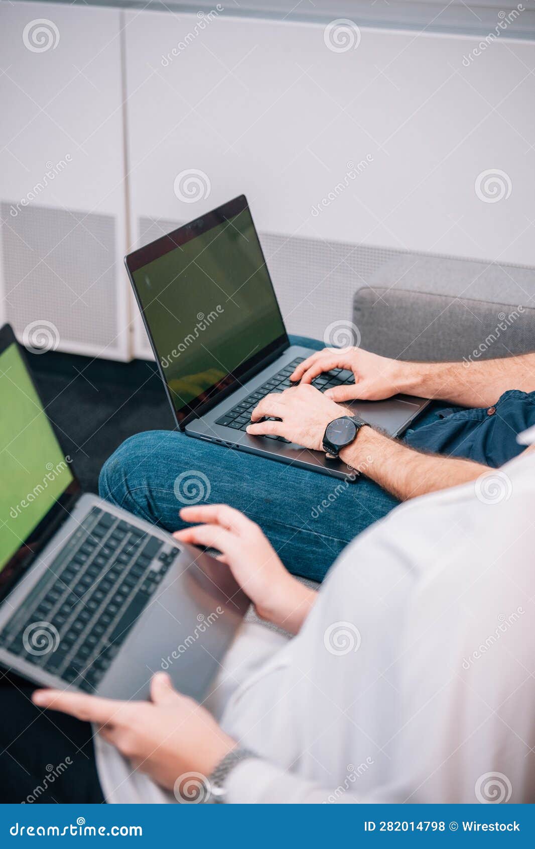 People Using Laptops while Seated on a Cozy Sofa: Workspace Environment ...