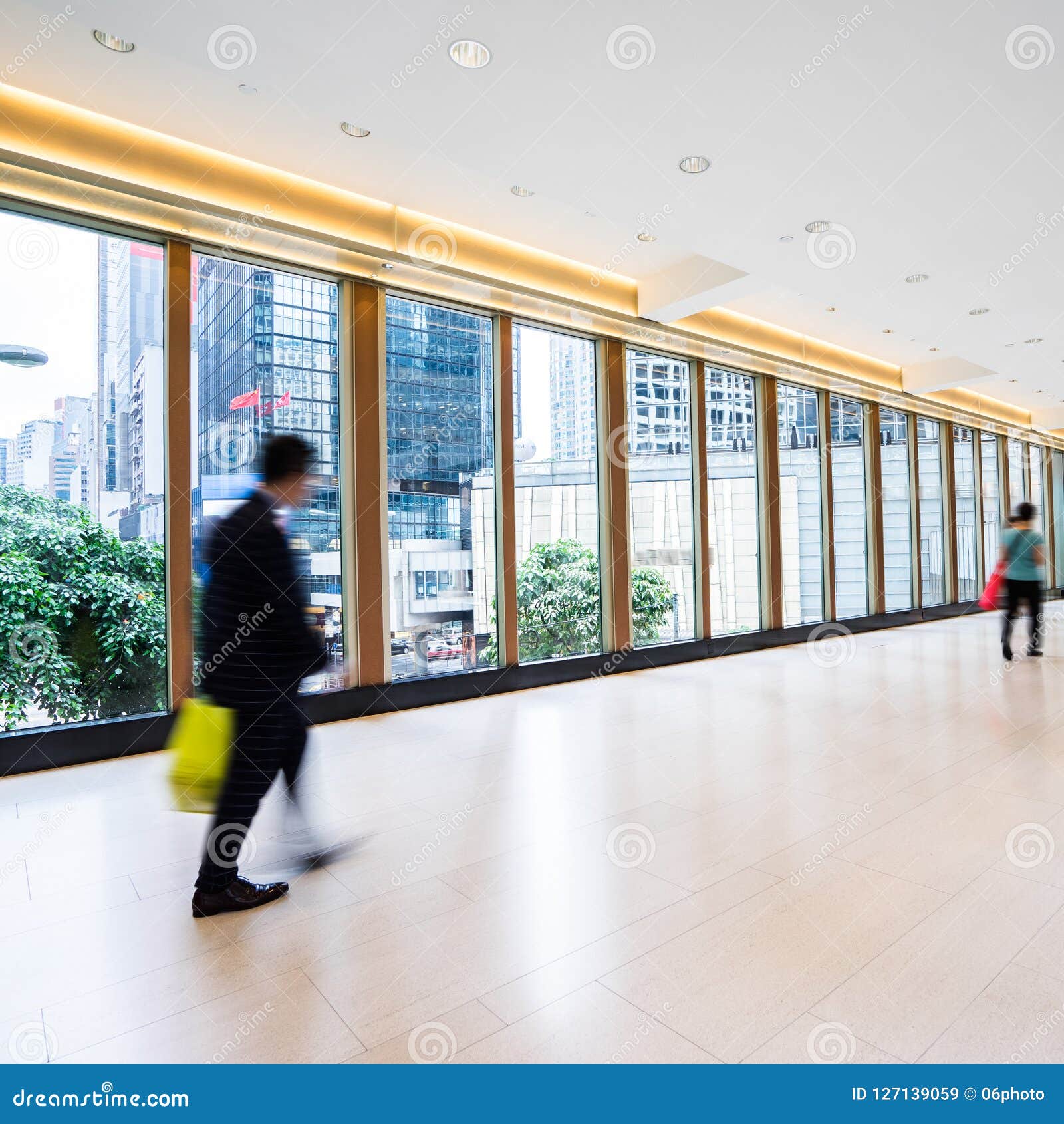 People walking in corridor stock image. Image of interior - 127139059