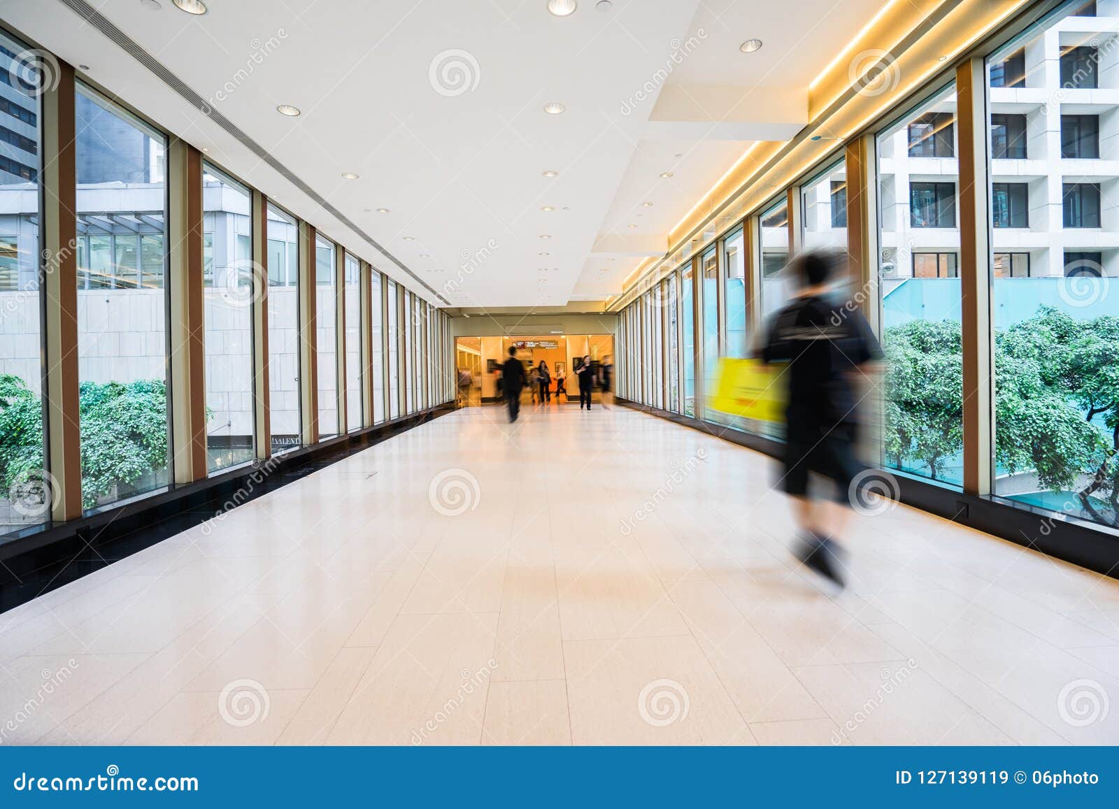People walking in corridor stock image. Image of corporate - 127139119