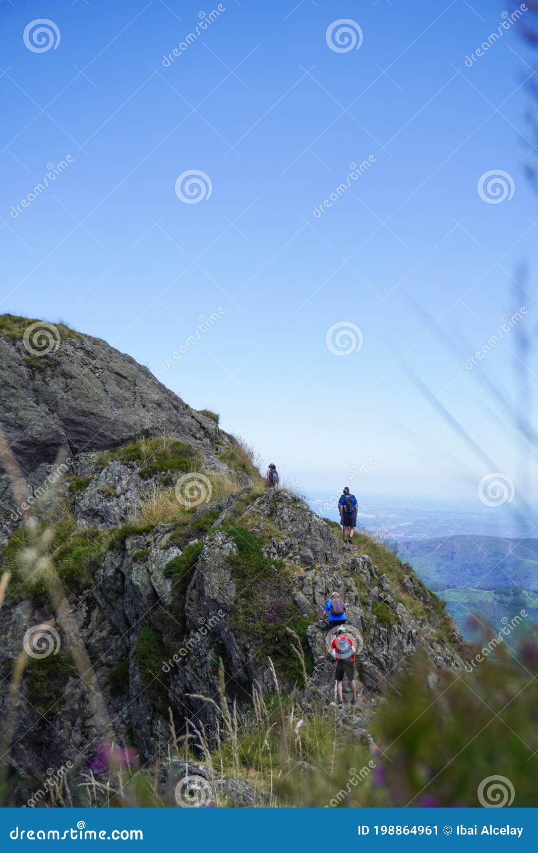 People Walking on the Edge of a Mountain Stock Image - Image of ...