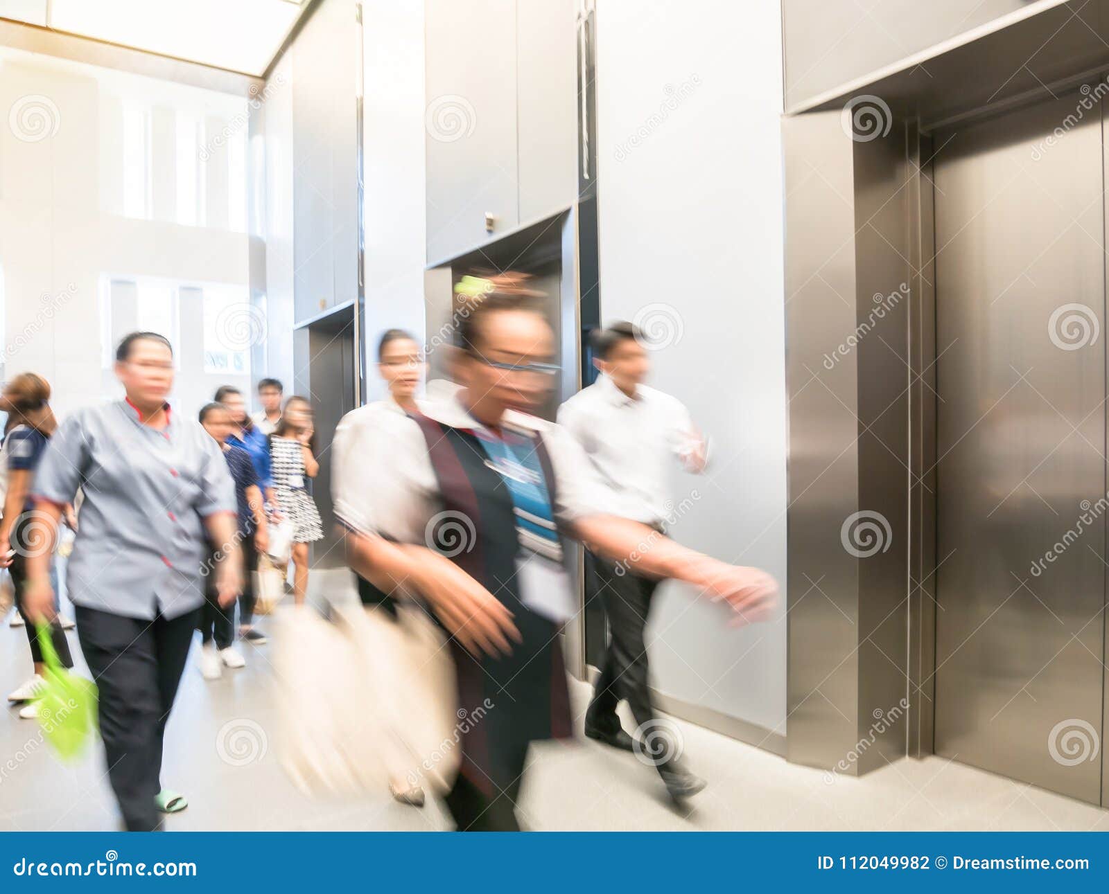 People Are Walking In Office Past Elevators, Modern Steel Elevator ...