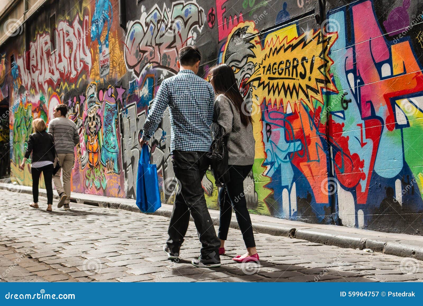 People Walking Past Graffiti Wall Editorial Photography - Image of ...