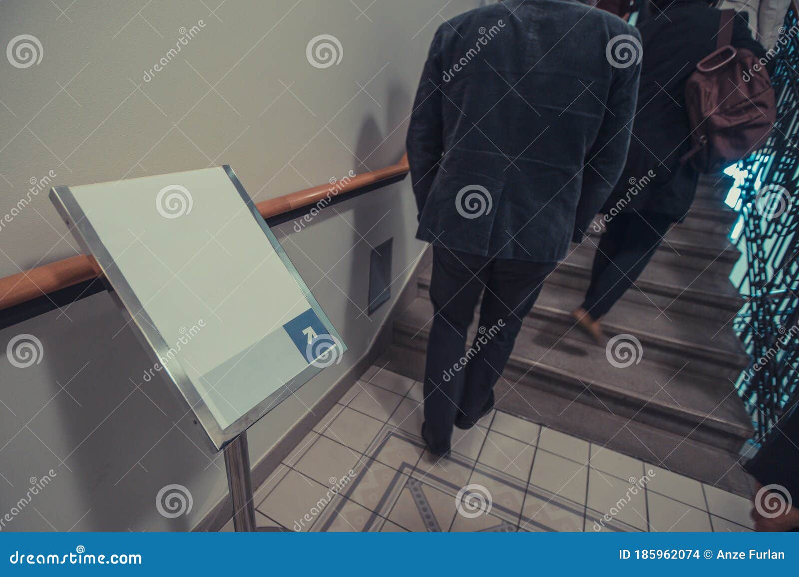People Walking Past Signboard Stock Photo - Image of direction ...