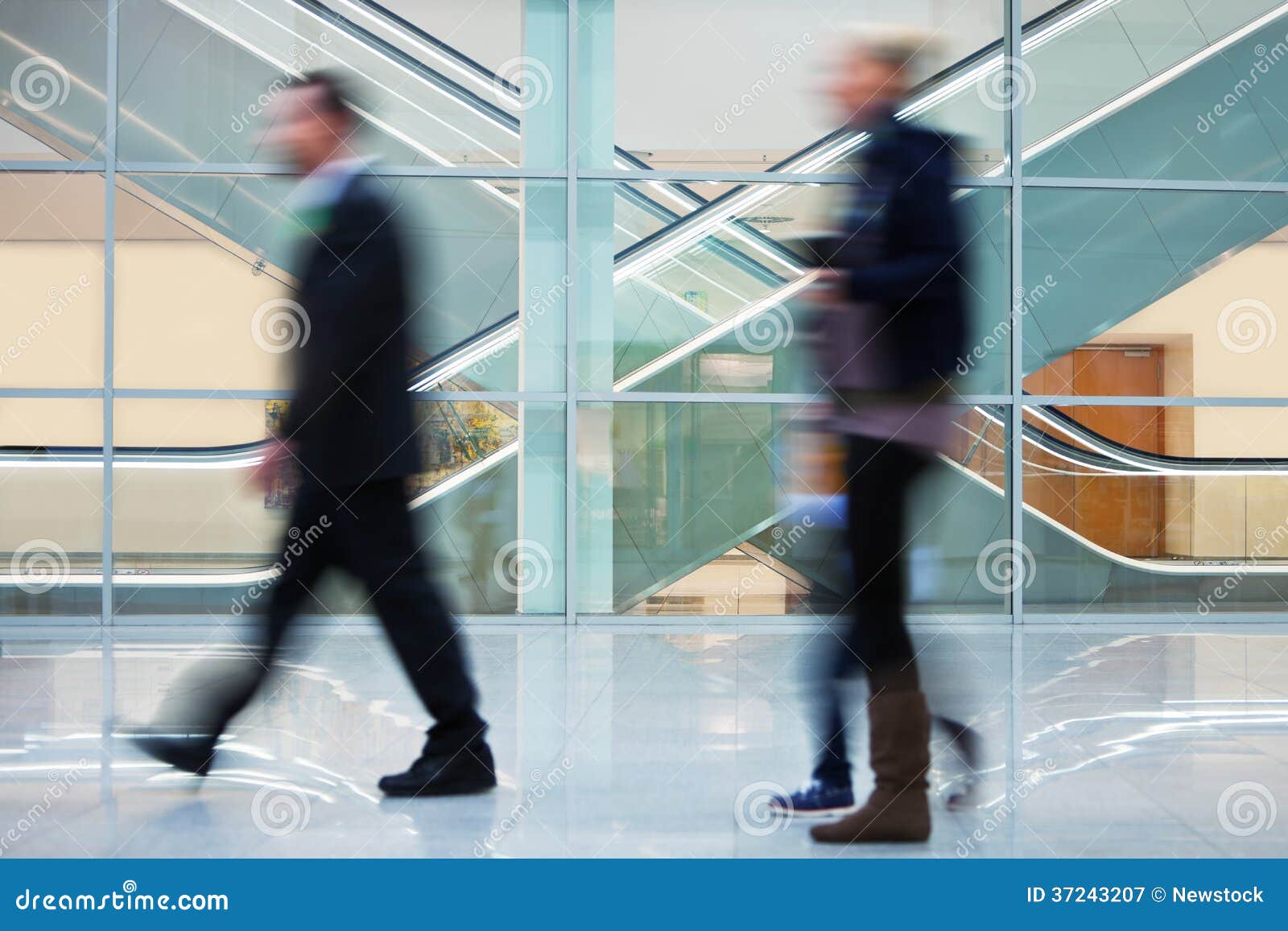 People Walking Quickly Down Hall in Office Building Stock Image - Image ...