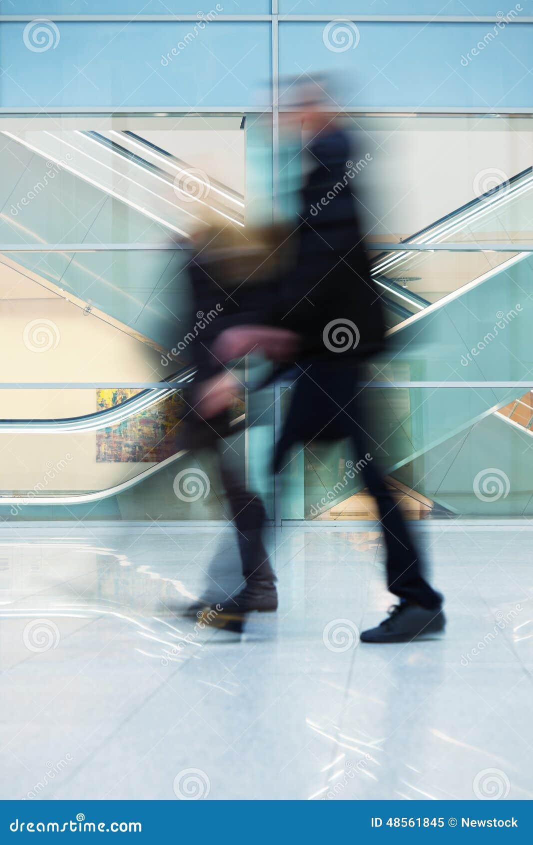People Walking Quickly Down Hall in Office Building Stock Image - Image ...